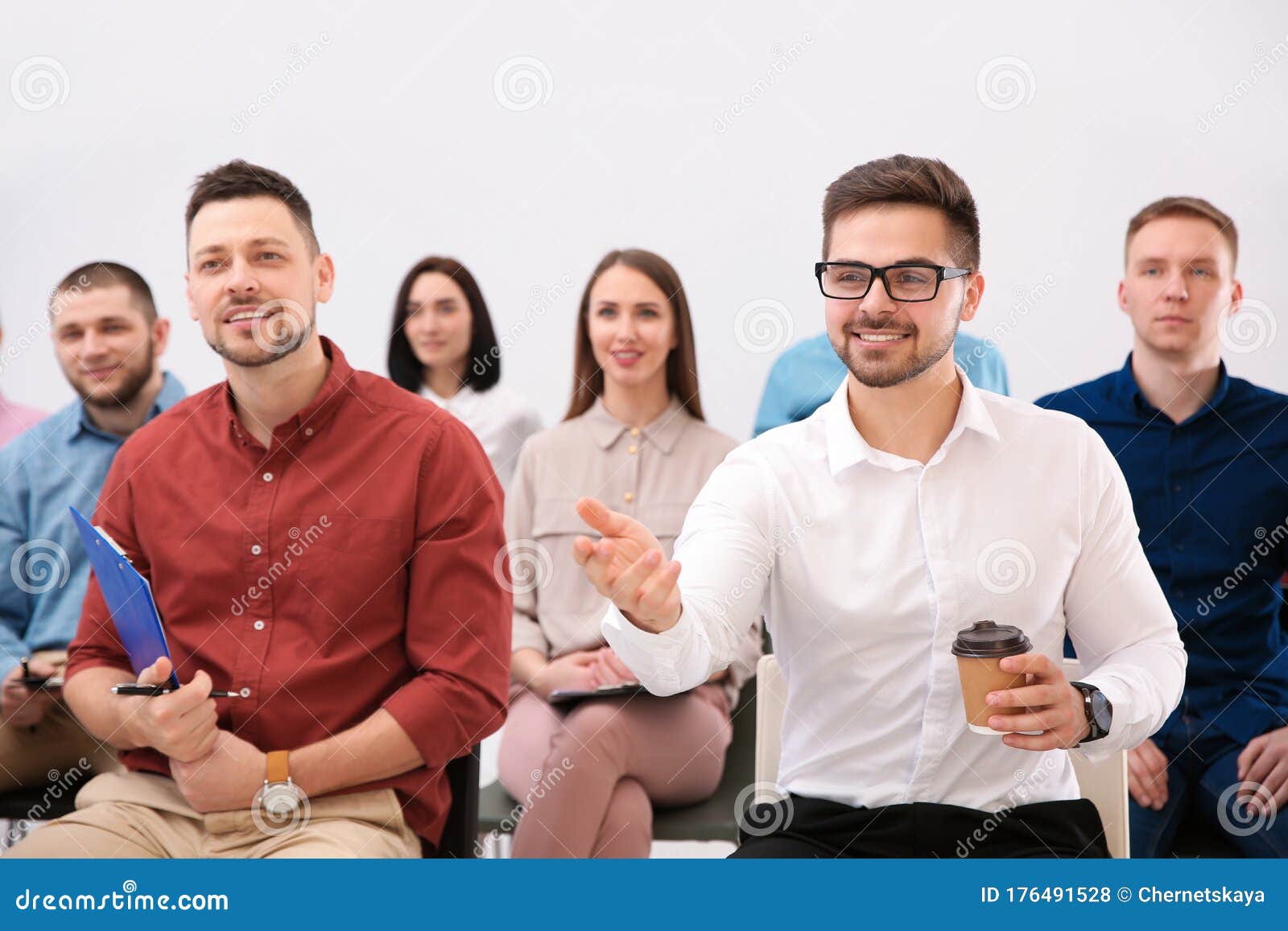 Young Man Asking Question at Business Training Stock Photo - Image of ...