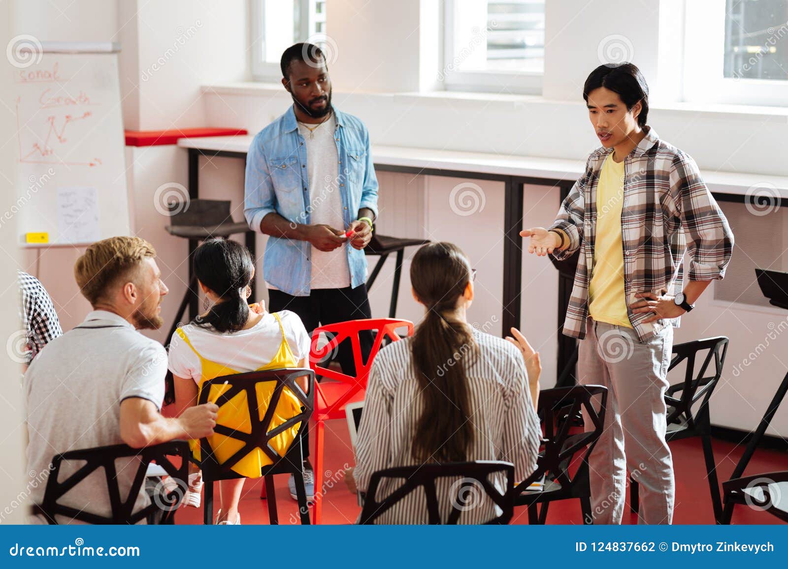 Young Man Asking Questions To the Group and Looking Serious Stock Photo ...