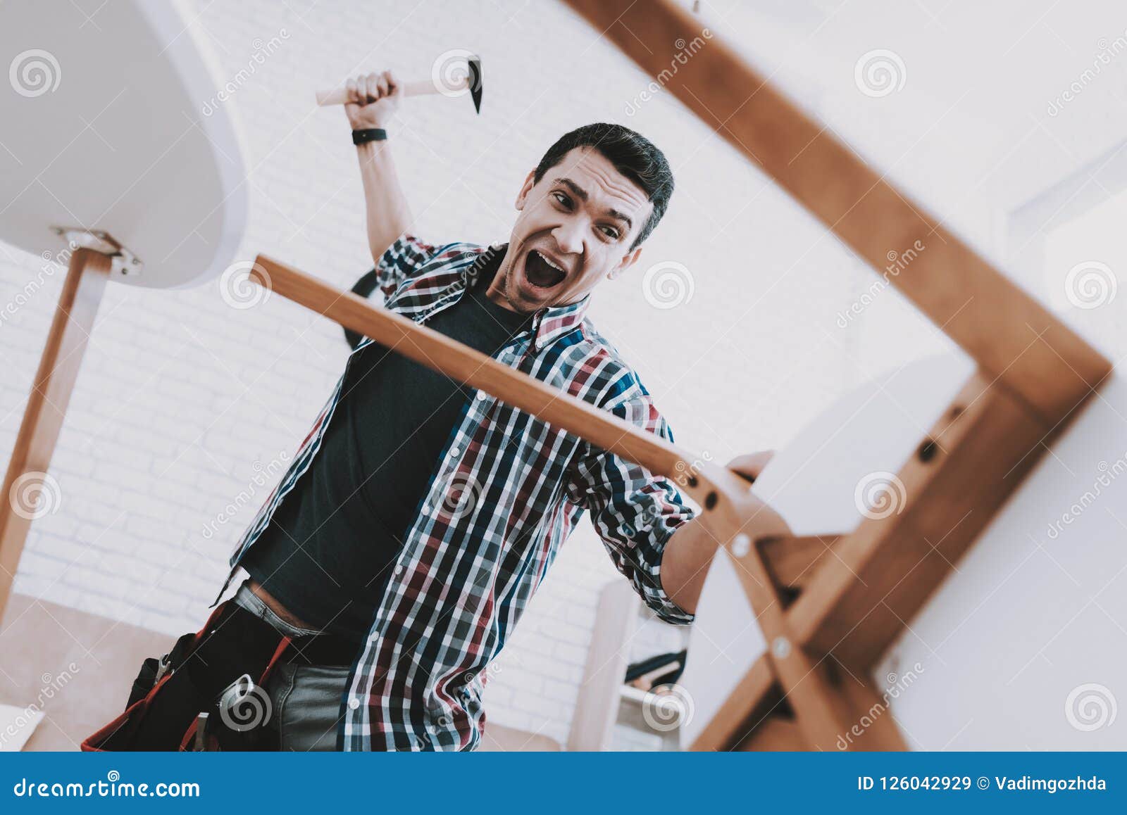 Young Man Assembling Coffee Table and Stools. Stock Image - Image of ...
