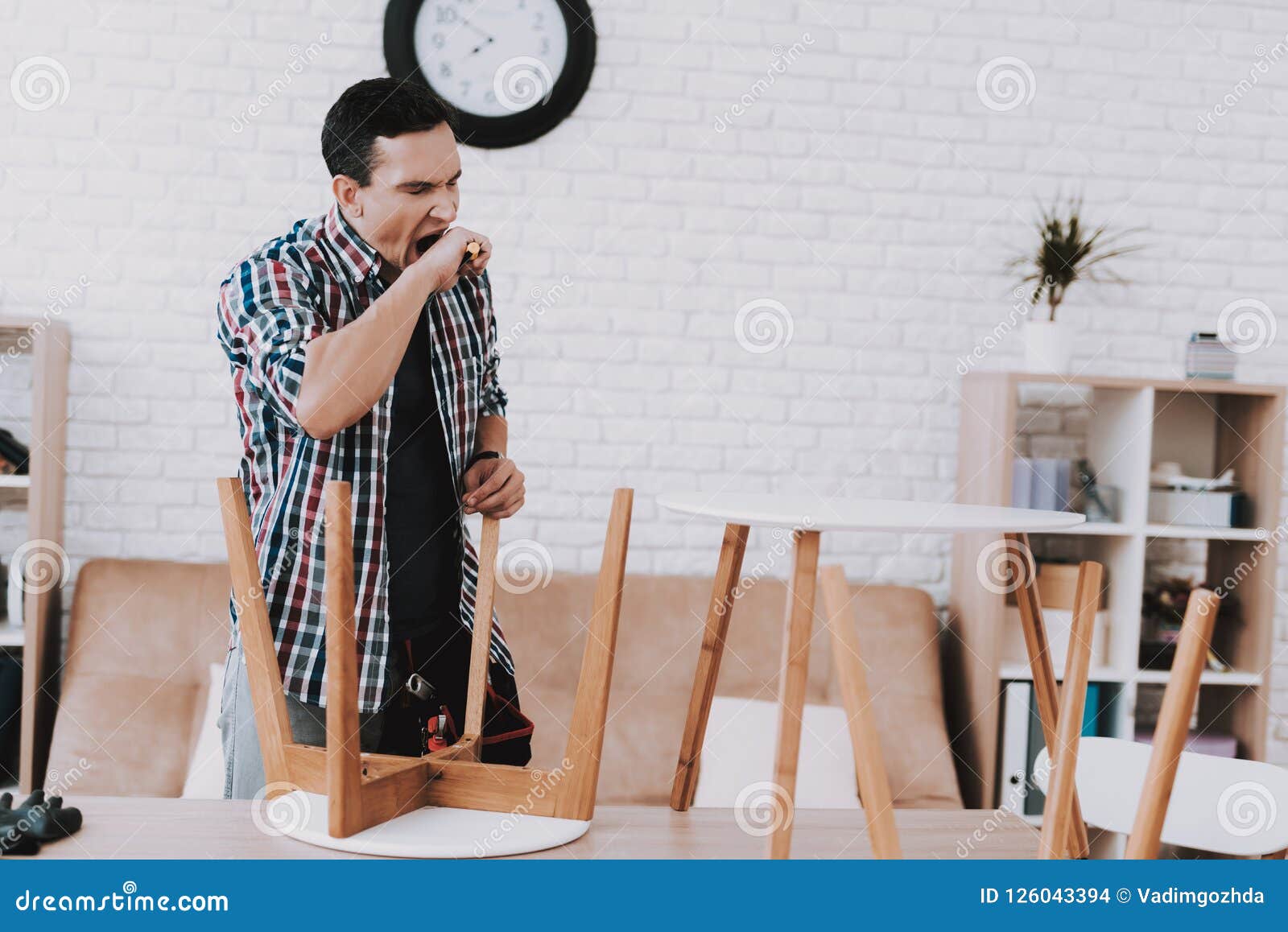 Young Man Assembling Coffee Table and Stools. Stock Photo - Image of ...