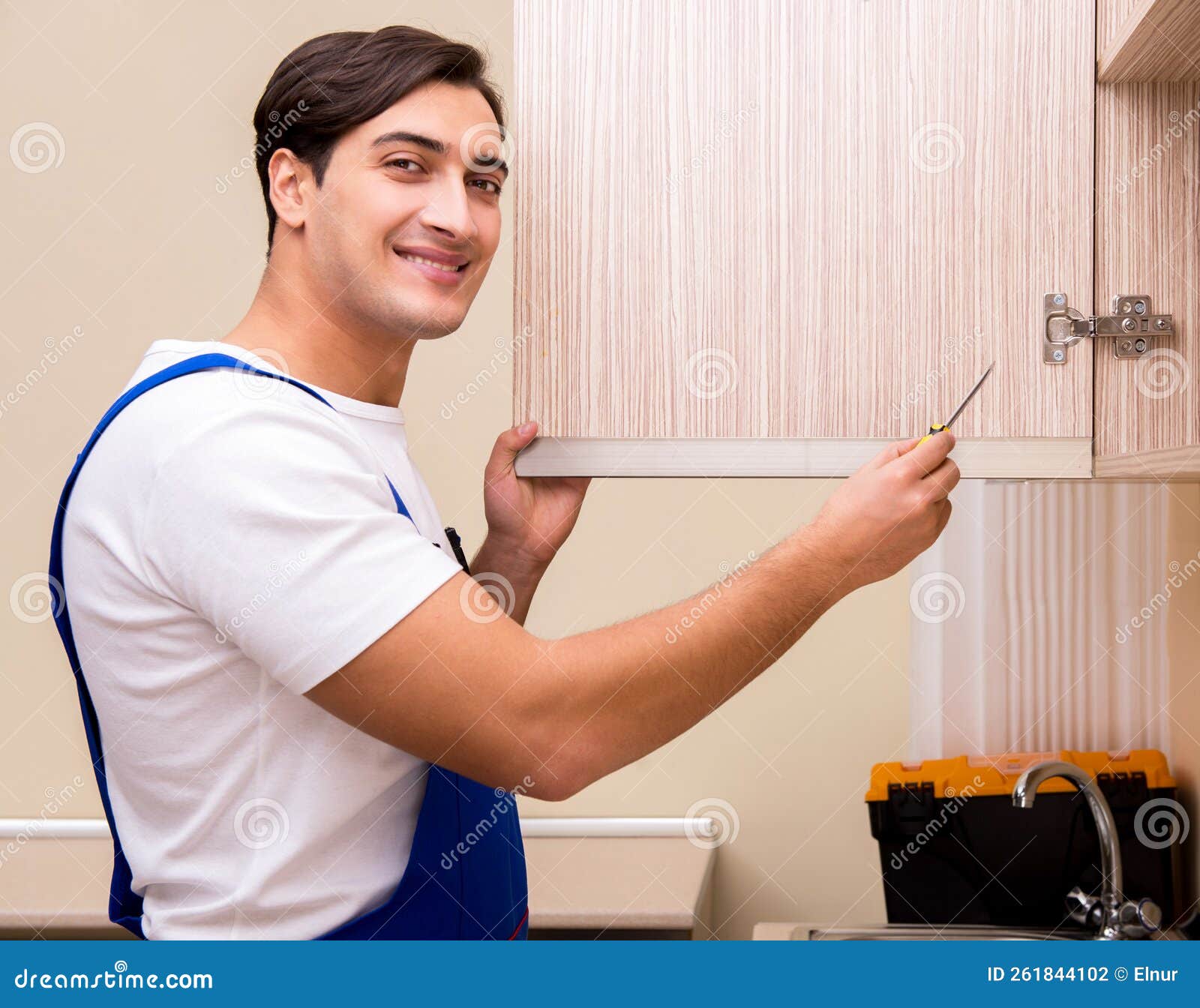 Young Man Assembling Kitchen Furniture Stock Photo - Image of equipment ...