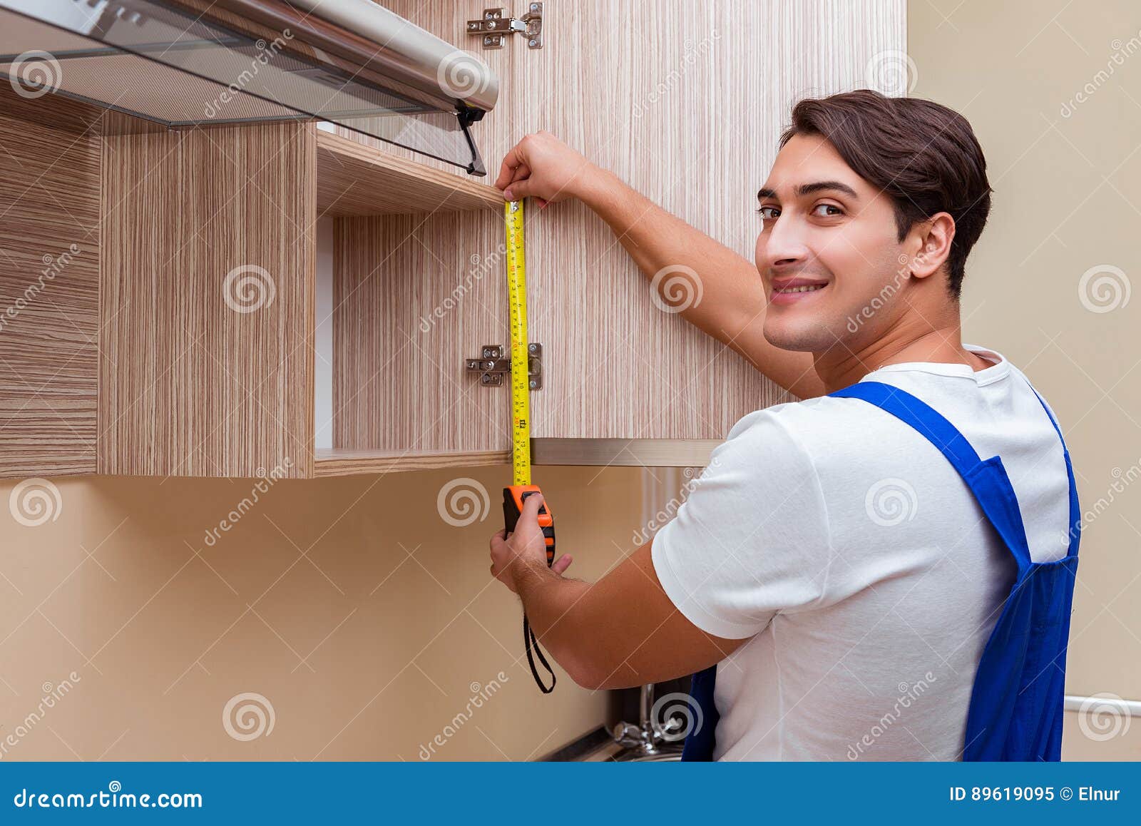 The Young Man Assembling Kitchen Furniture Stock Image - Image of home ...