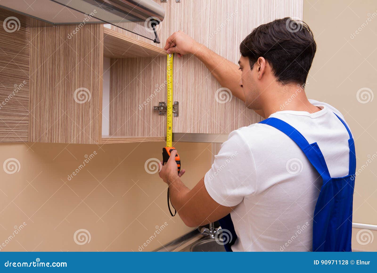 The Young Man Assembling Kitchen Furniture Stock Photo - Image of ...