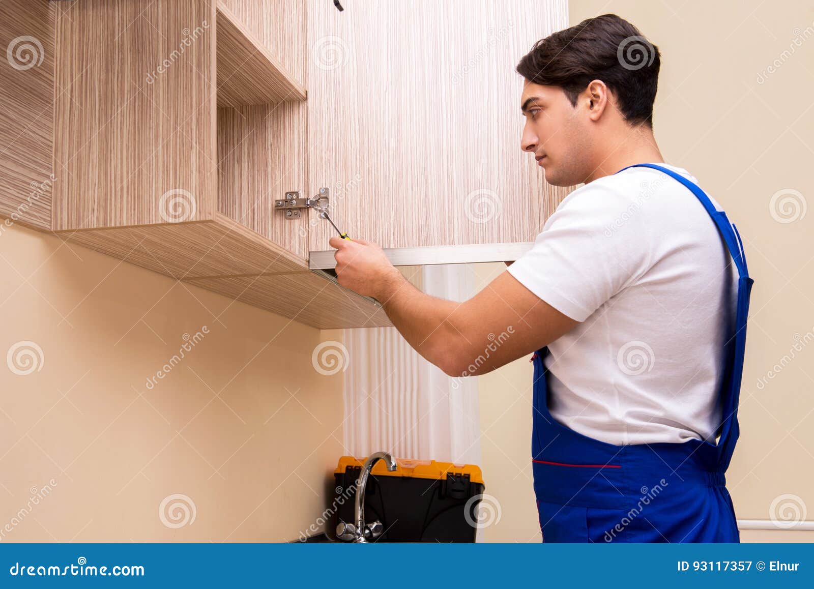 The Young Man Assembling Kitchen Furniture Stock Image - Image of ...