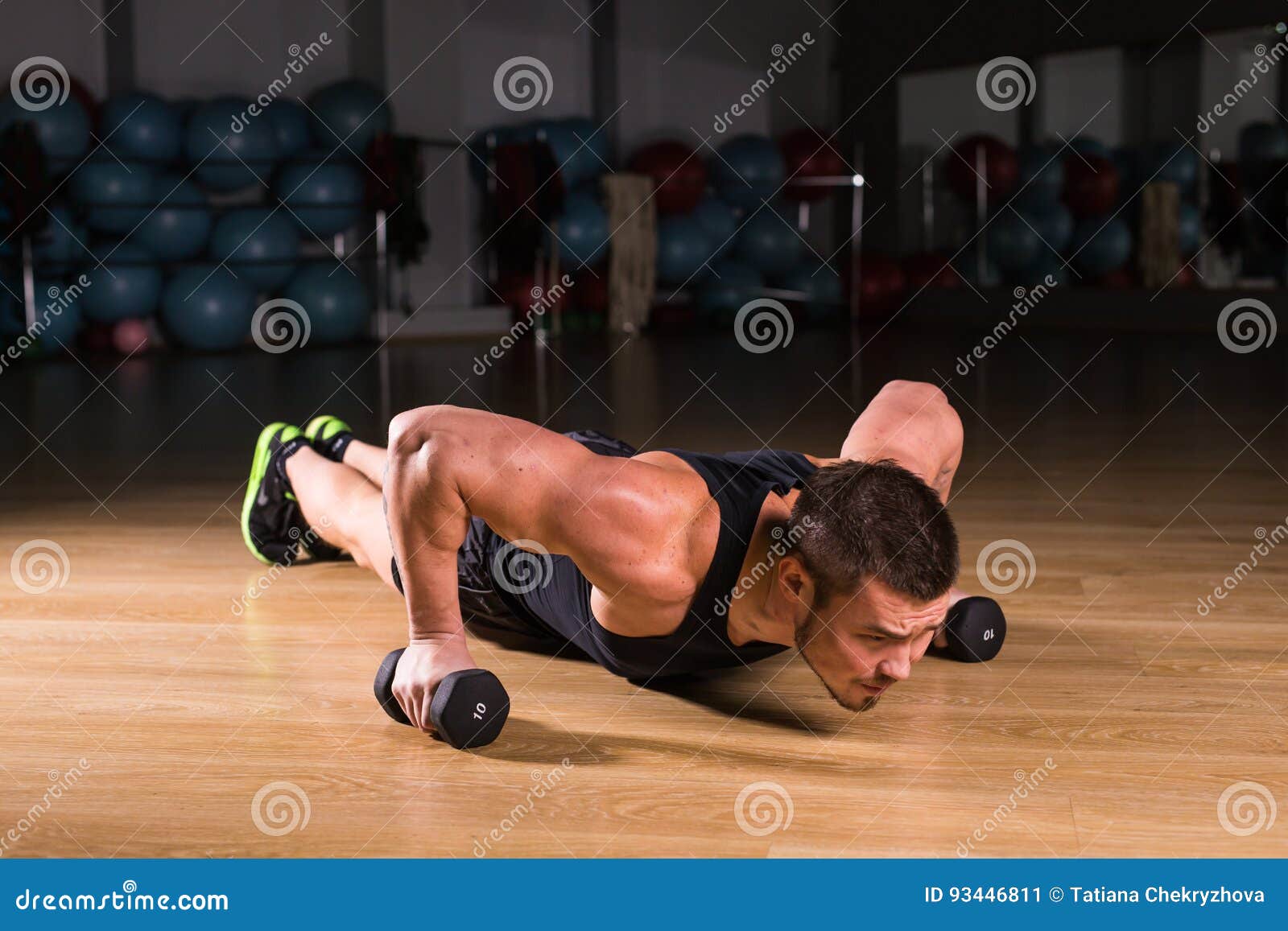 Young Man Athlete Doing Pushups with Dumbbells As Part of Bodybuilding ...
