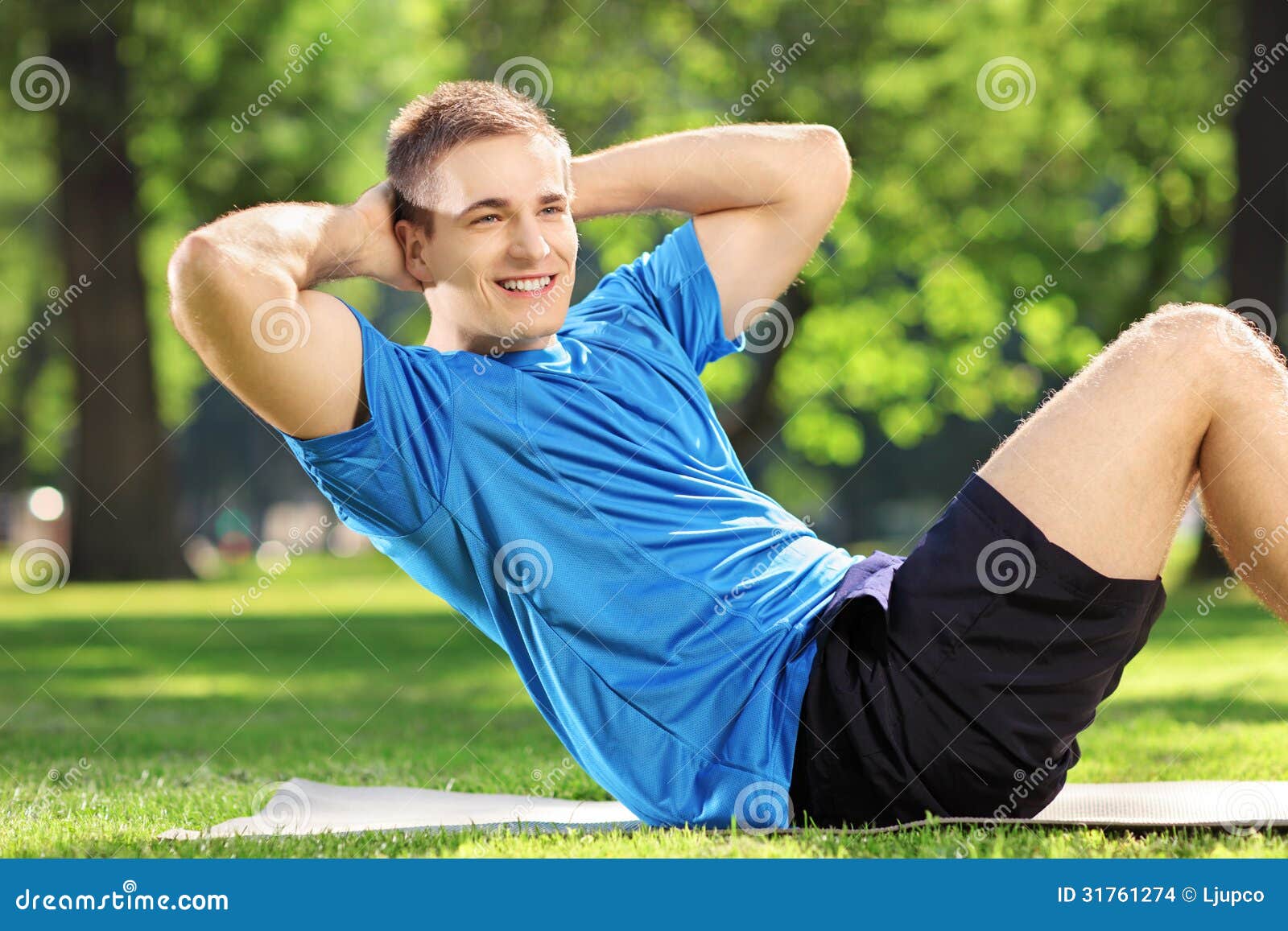 Young Man Athlete Exercising Abs in a Park Stock Photo - Image of ...