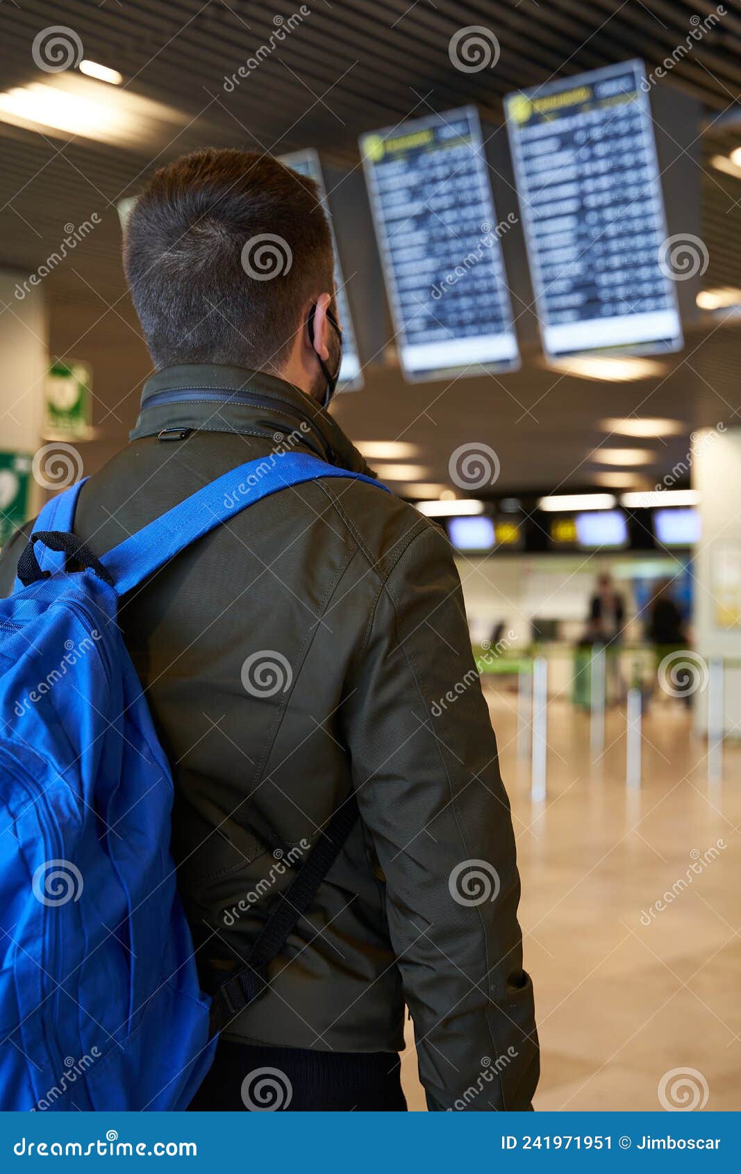 Young Man with Backpack in Airport Looking Flight Timetable Stock Image ...
