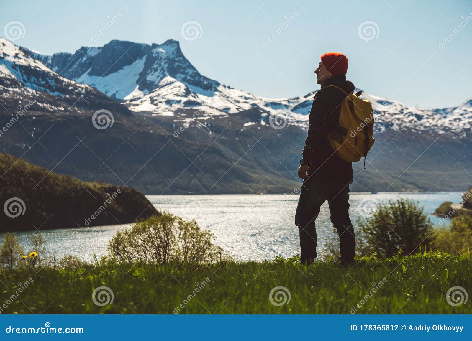 Young Man with a Backpack Standing on the Background of Mountains and ...