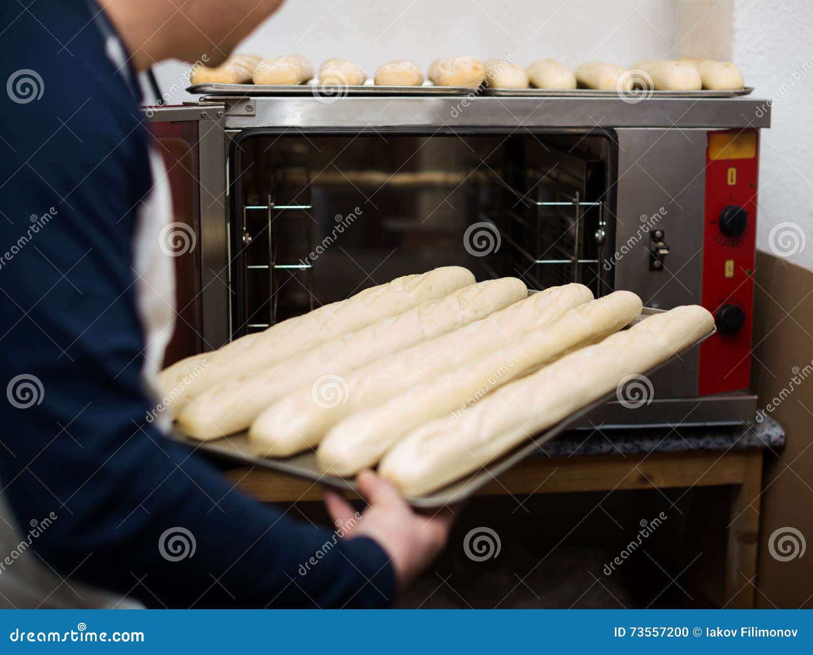Young man baking bread stock photo. Image of catering - 73557200