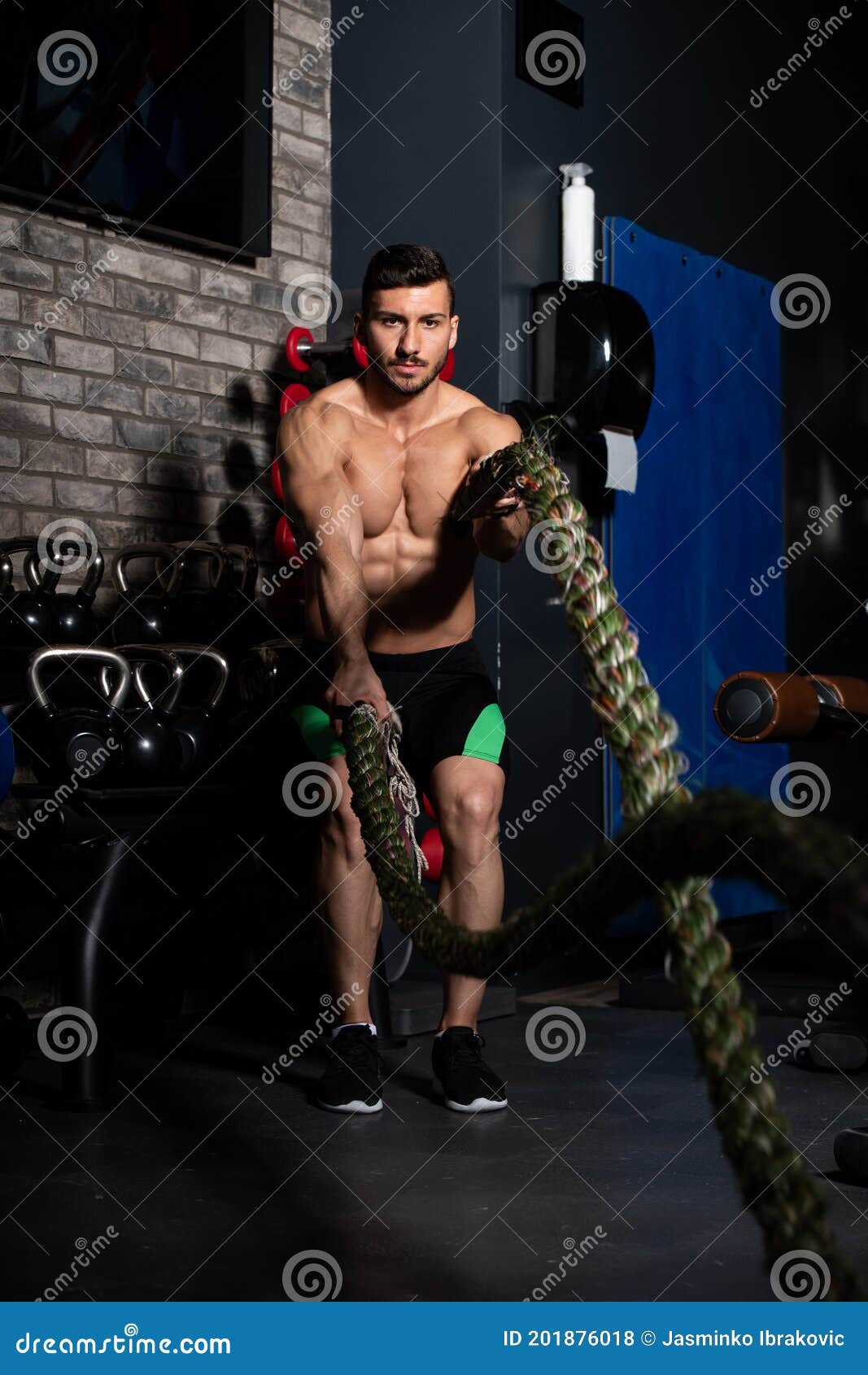 Young Man Battling Ropes at Gym Workout Exercise Stock Photo - Image of ...