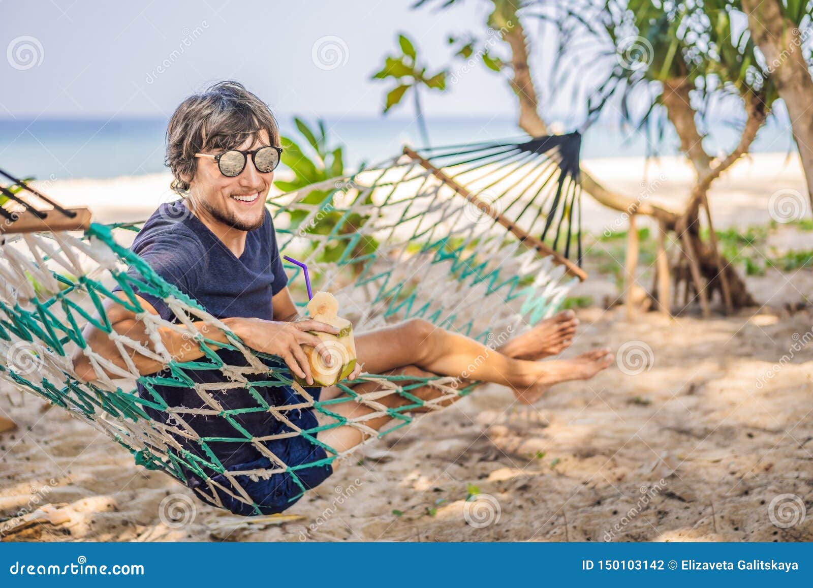 Young Man on the Beach in a Hammock with a Drink Stock Photo - Image of ...