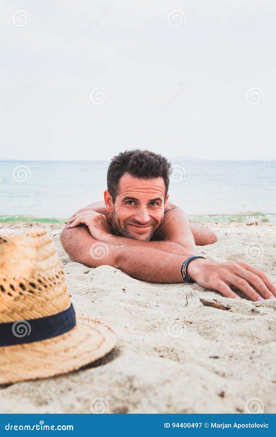Young Man on the Beach Lying in the Sand Stock Image - Image of ...