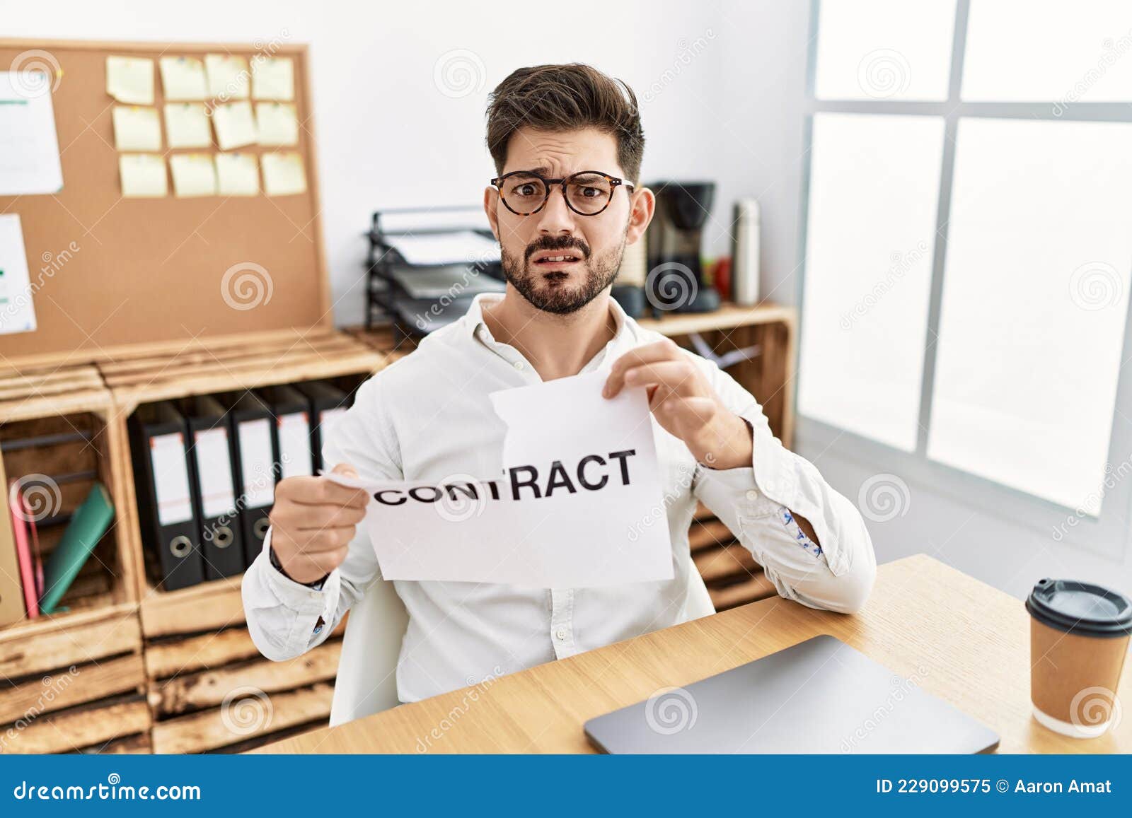 Young Man with Beard Breaking Contract Paper at the Office Clueless and ...