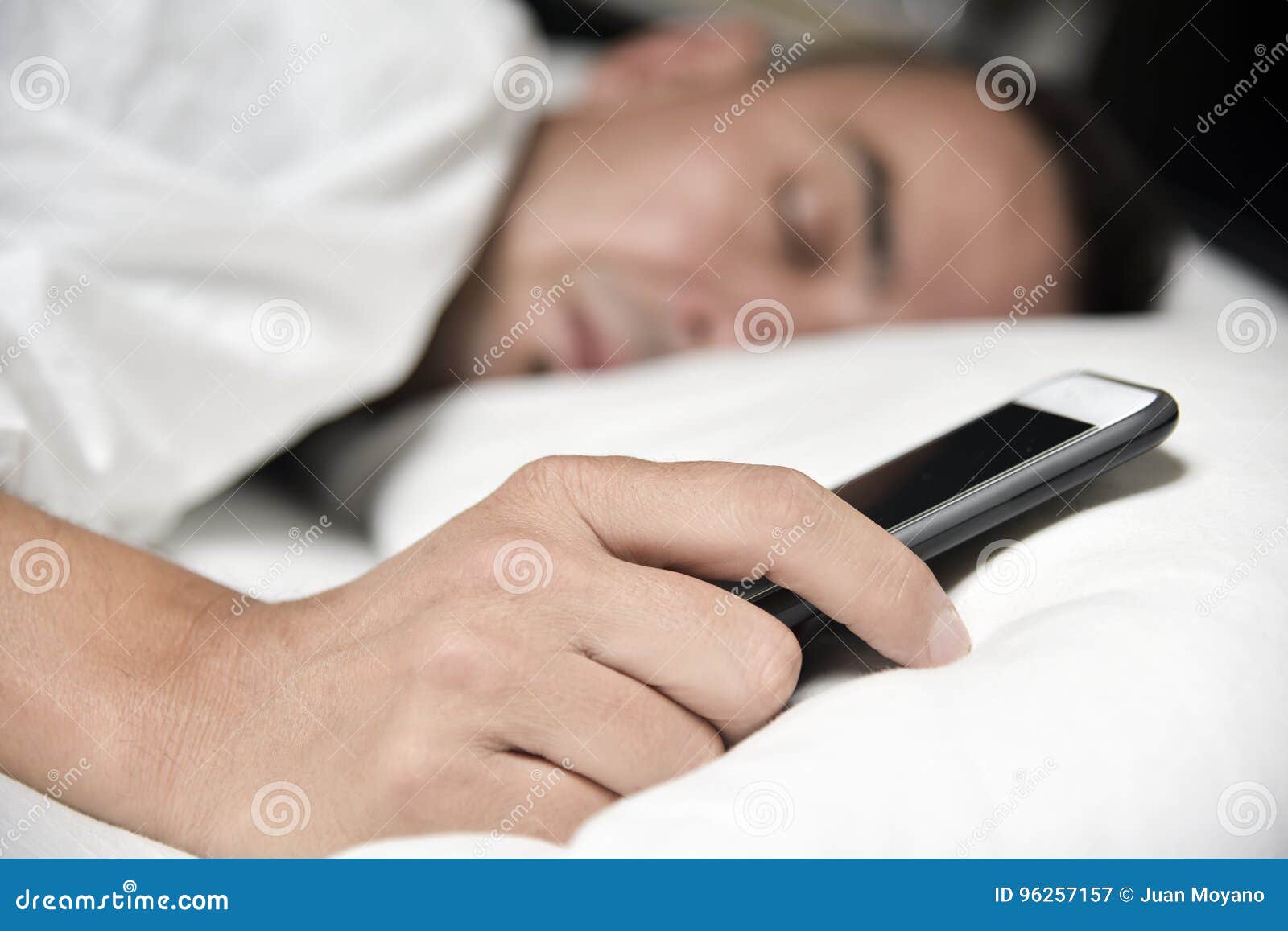 Young Man in Bed Grabbing His Smartphone Stock Image - Image of home ...