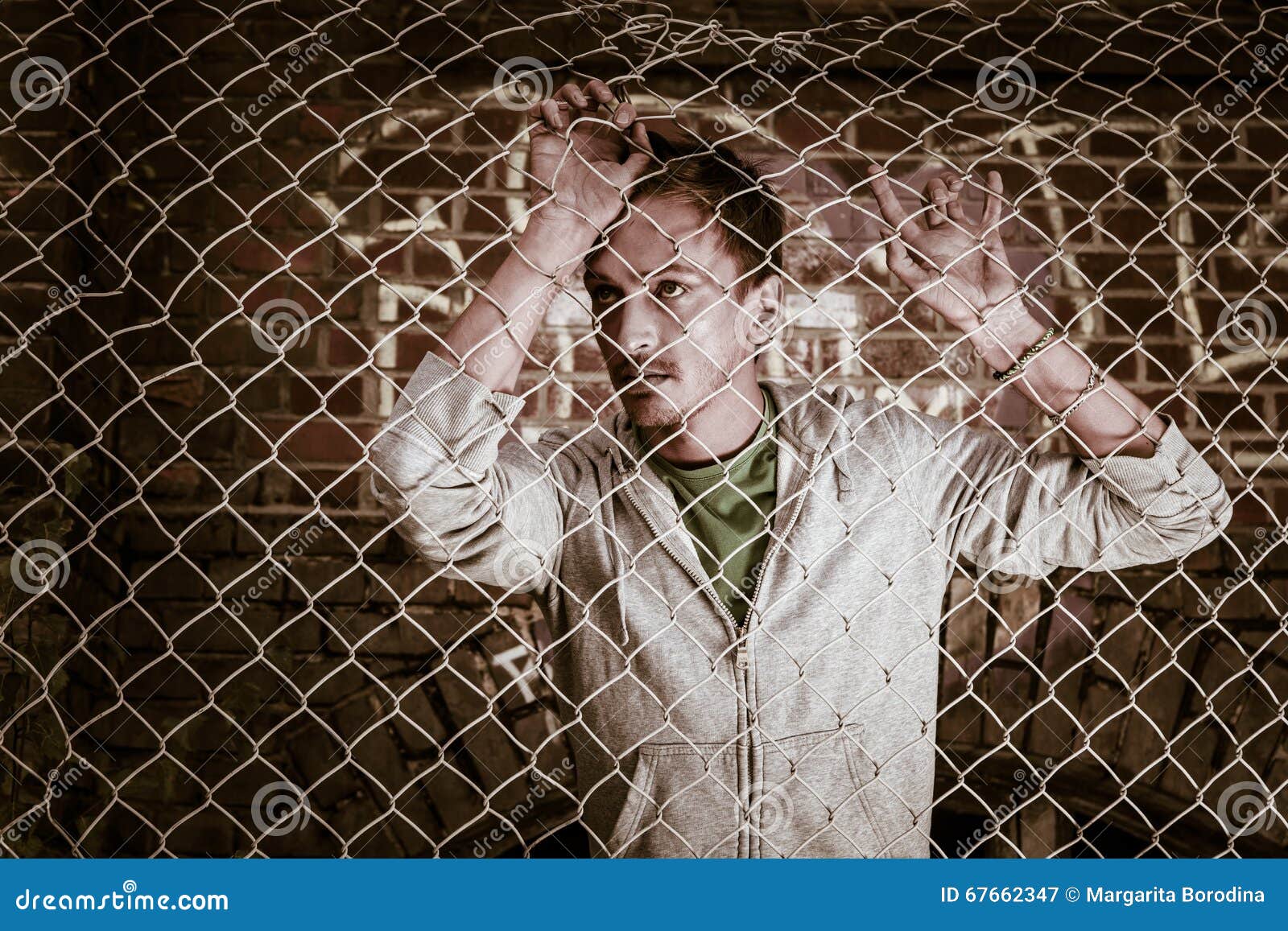 A Young Man Behind Bars Close Stock Image - Image of male, hood: 67662347
