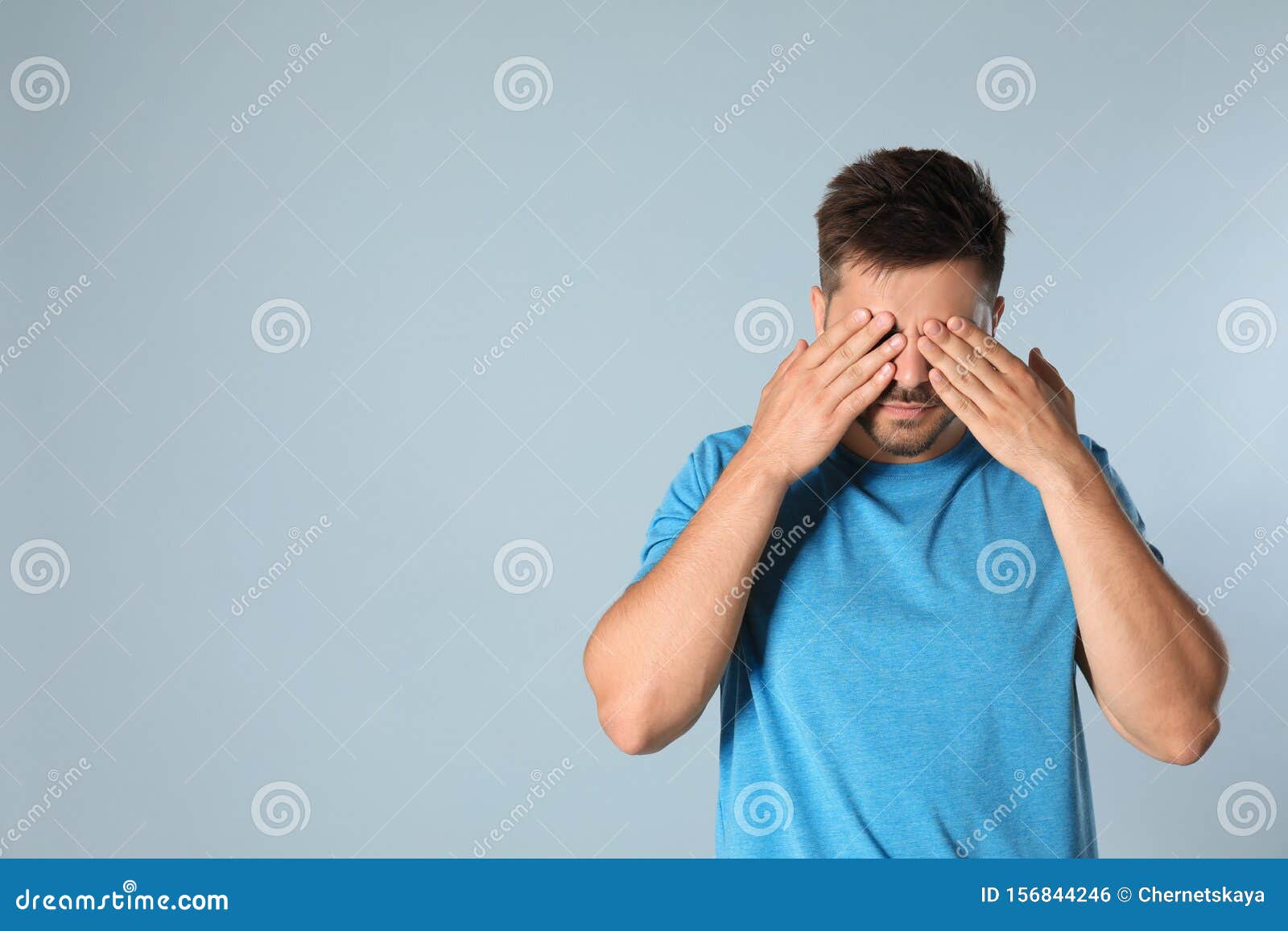 Young Man Being Blinded on Grey Background Stock Photo - Image of ...