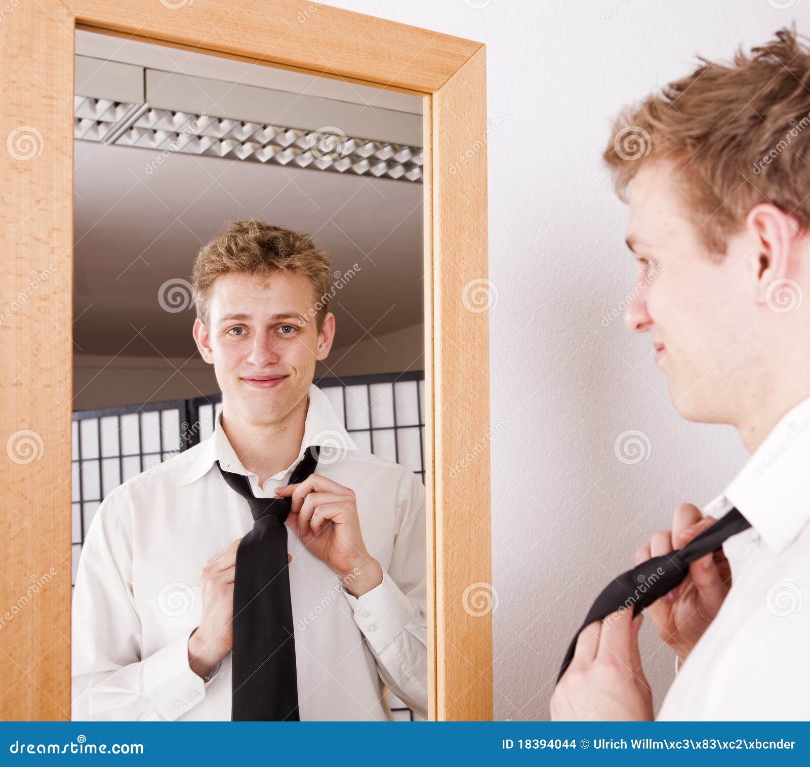 Young man binding his tie stock photo. Image of caucasian - 18394044