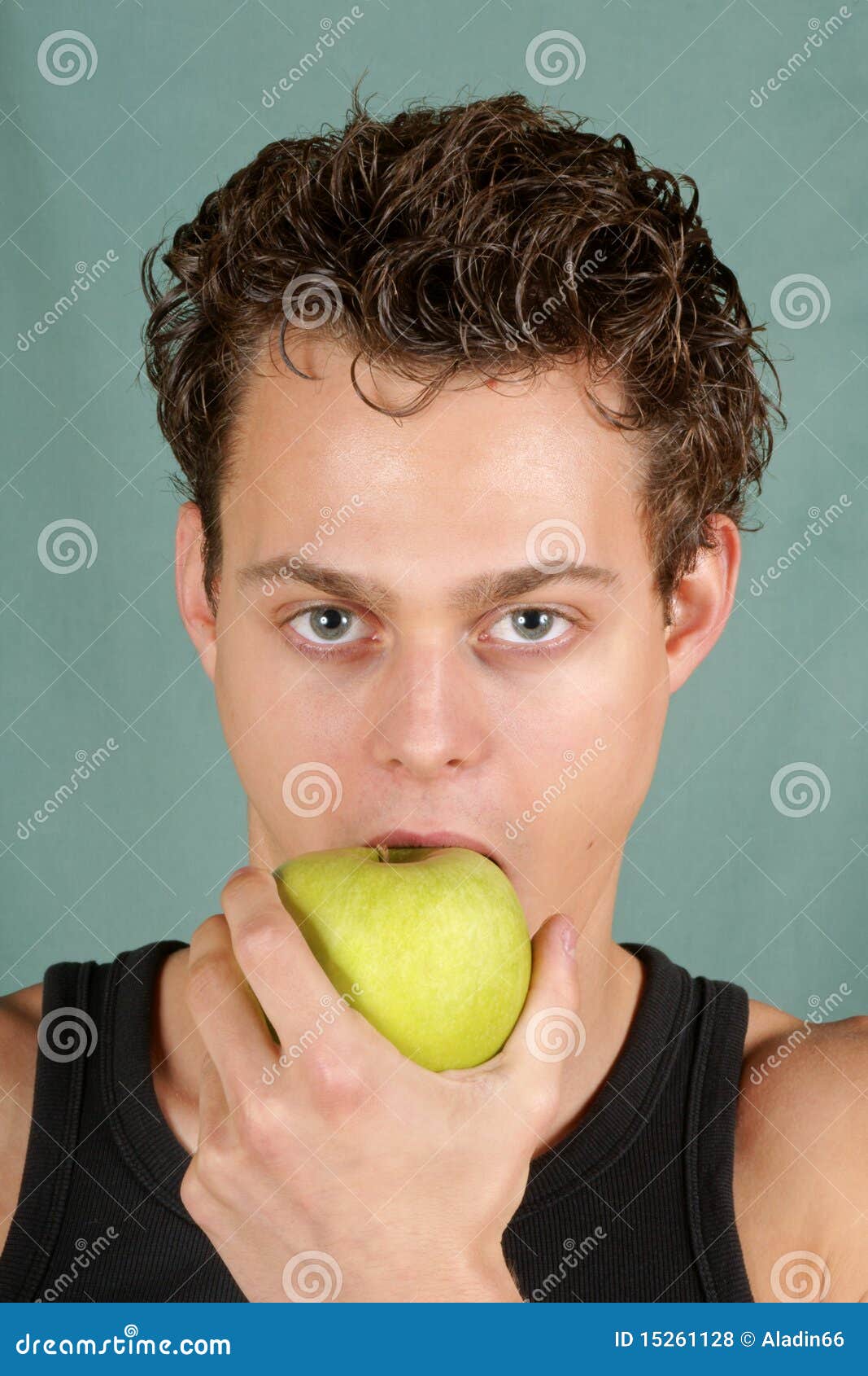 Young man biting an apple stock photo. Image of hair - 15261128