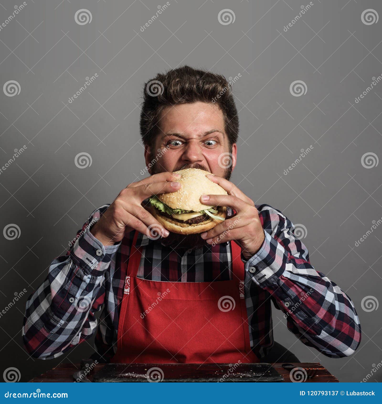 Man biting black hamburger stock image. Image of beard - 120793137
