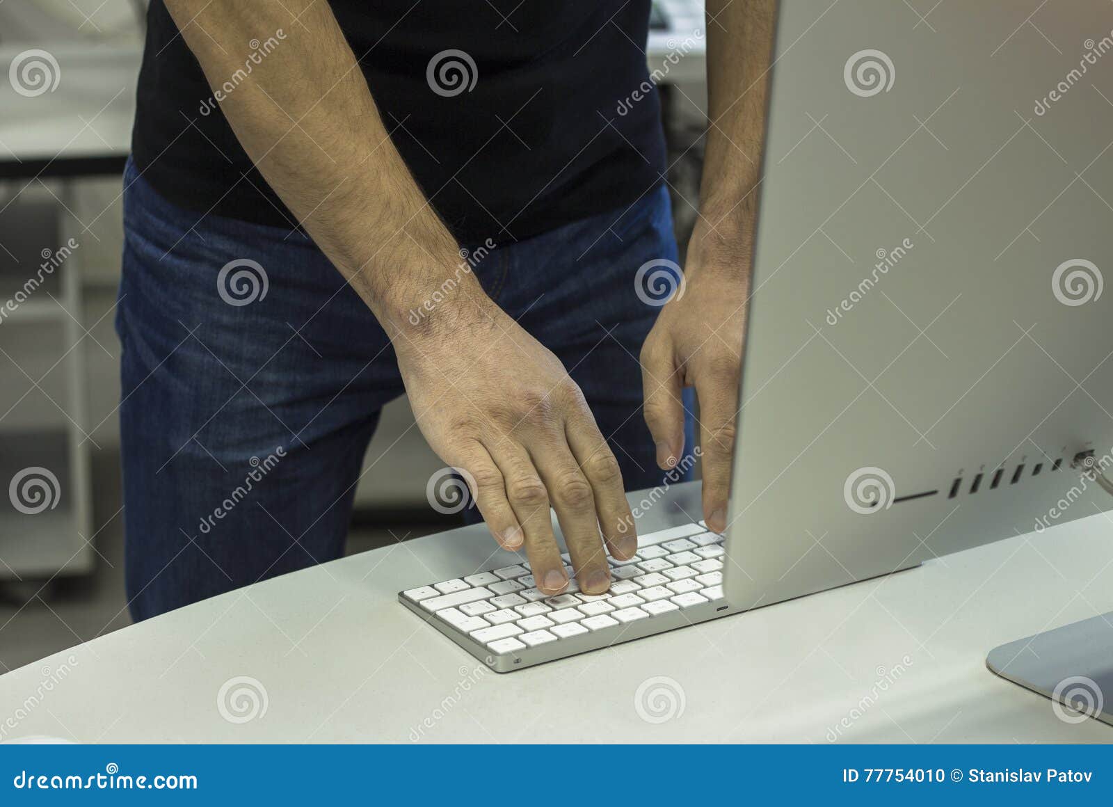 Young Man in a Black T-shirt Working with Computer, Standing Stock ...