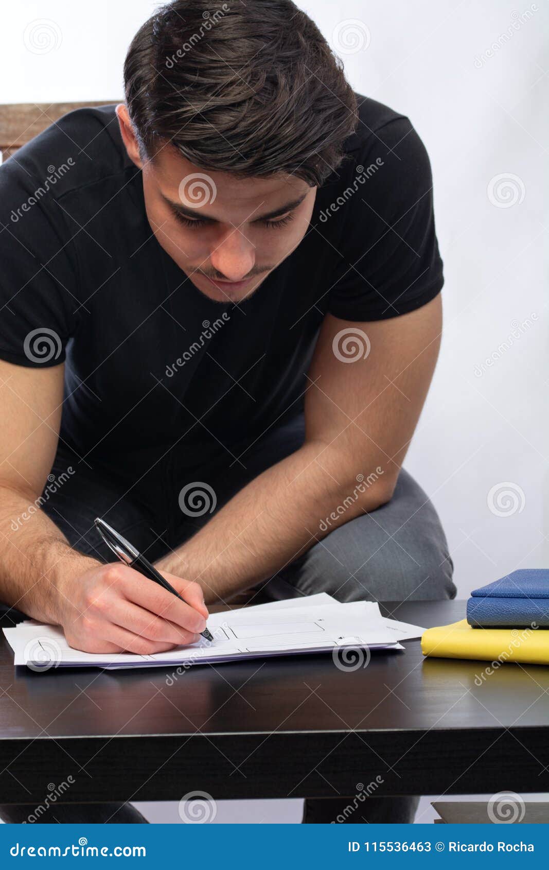 Young man writing stock image. Image of work, desk, paperwork - 115536463