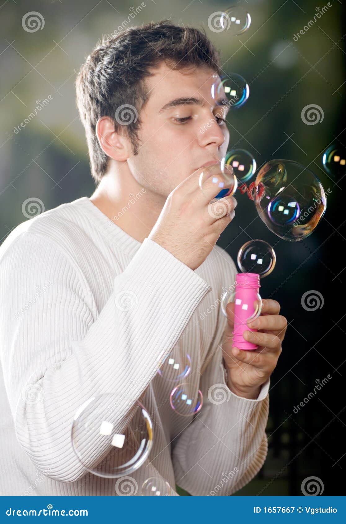 Young man blowing bubbles stock image. Image of young - 1657667