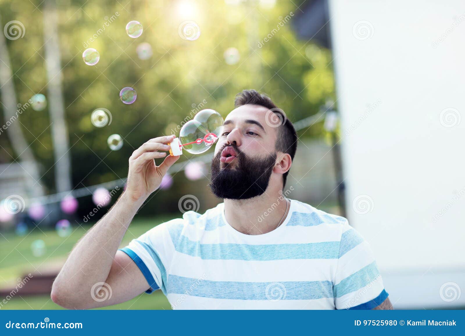 Young Man Blowing Bubbles Outdoors Stock Photo - Image of adult, woman ...