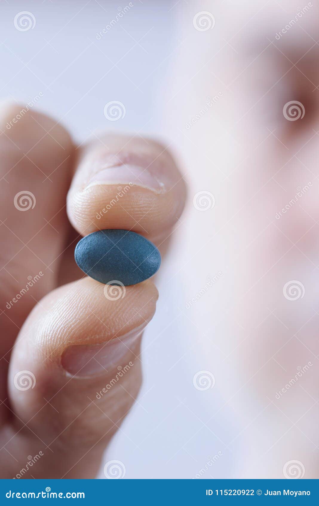 Young man with a blue pill stock photo. Image of medicine - 115220922