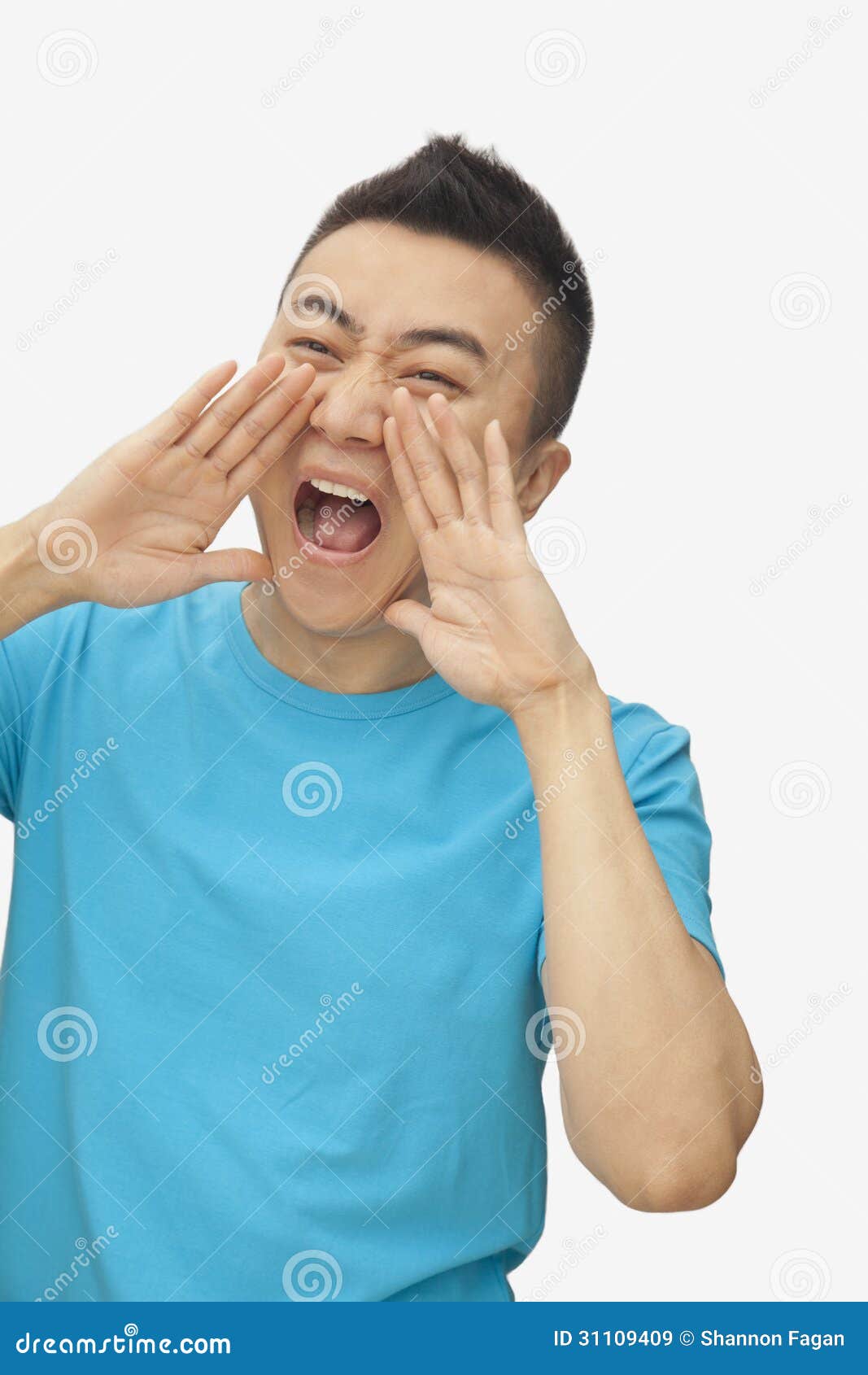 Young Man in Blue Shirt Shouting with Hands by Mouth, Studio Shot Stock ...