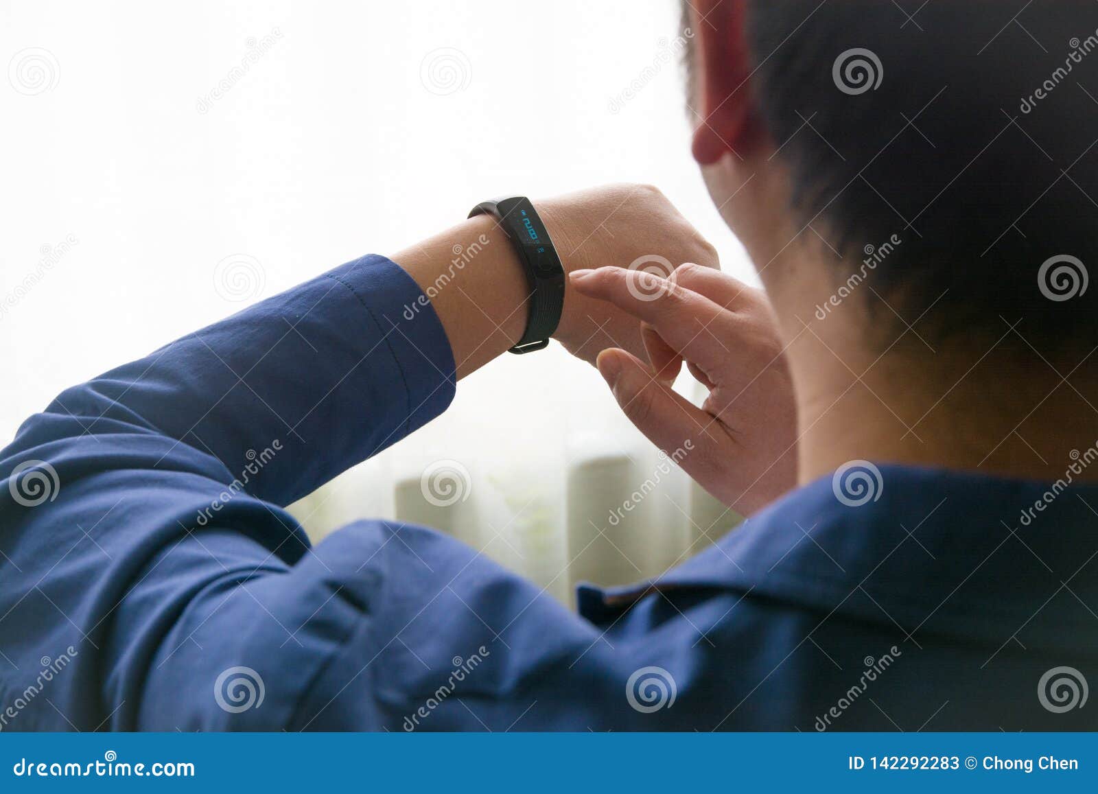 Young Man in Blue Suit checking His Wristband Stock Image - Image of ...