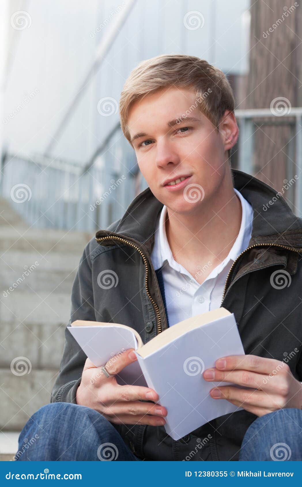 Young man with book stock image. Image of paperback, coat - 12380355