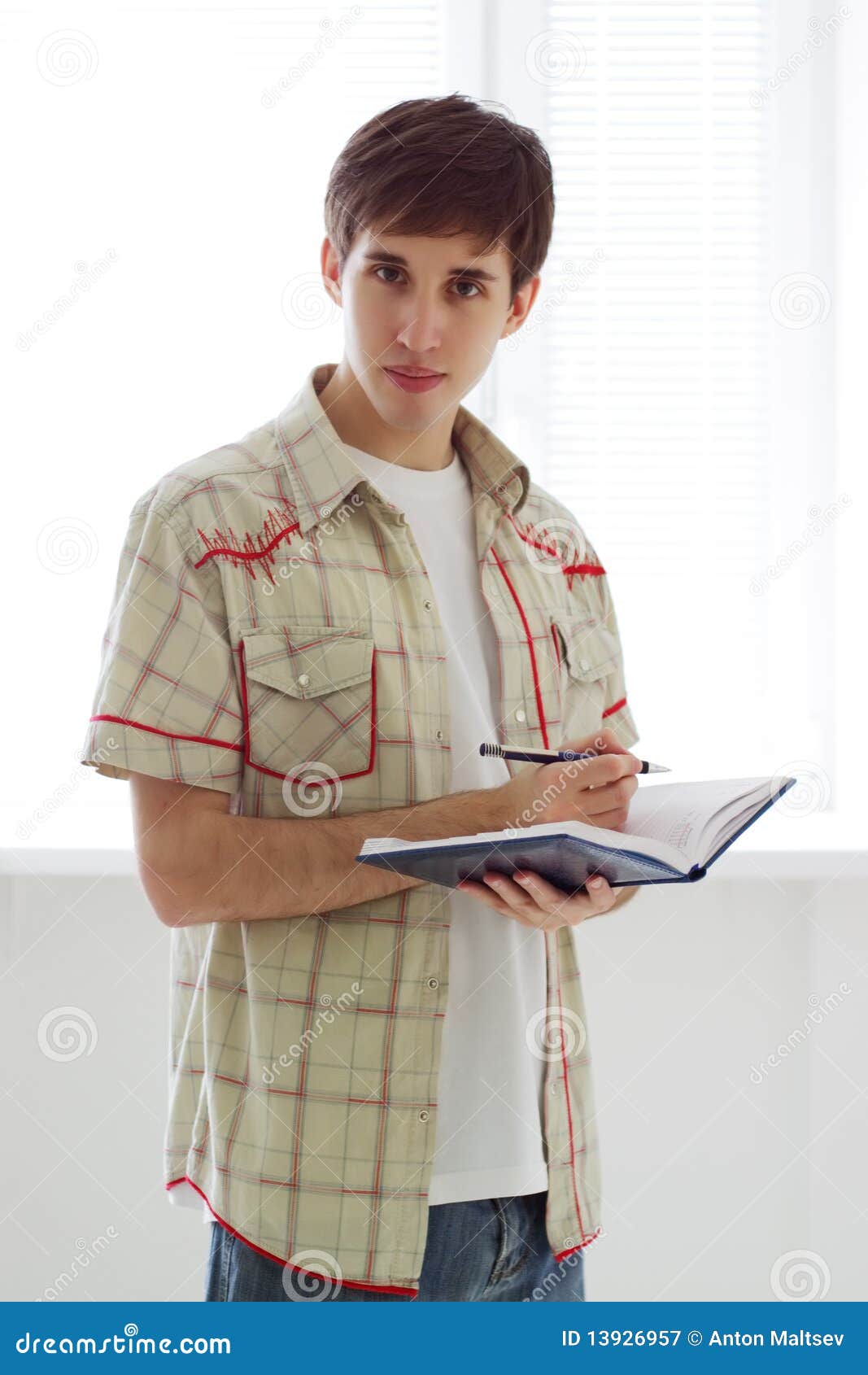 Young man with a book stock image. Image of serious, standing - 13926957