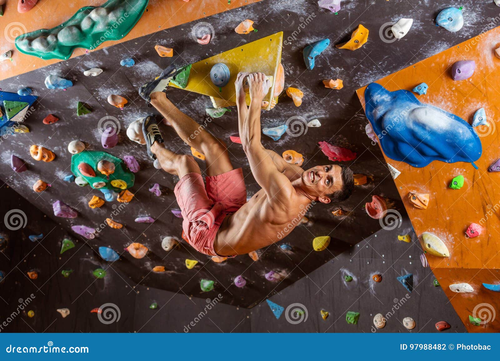 Young Man Bouldering in Indoor Climbing Gym, Solving Challenging Stock ...