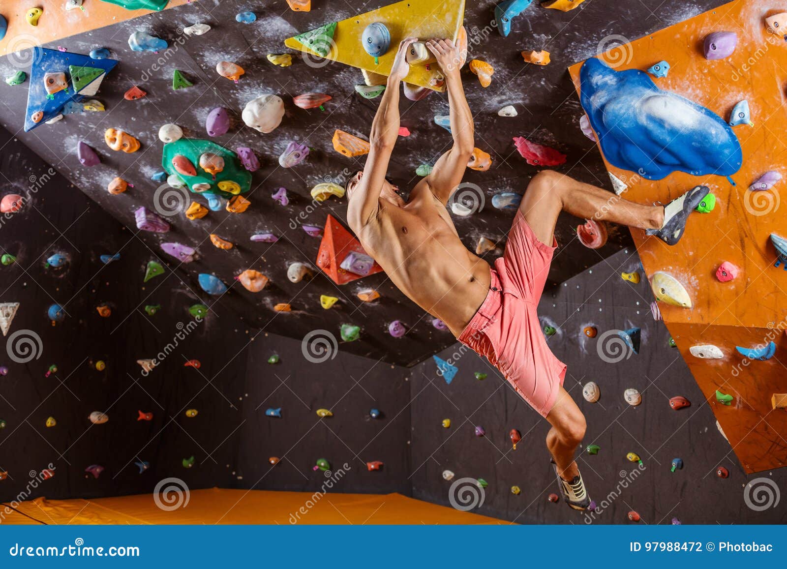 Young Man Bouldering in Indoor Climbing Gym Stock Photo - Image of ...
