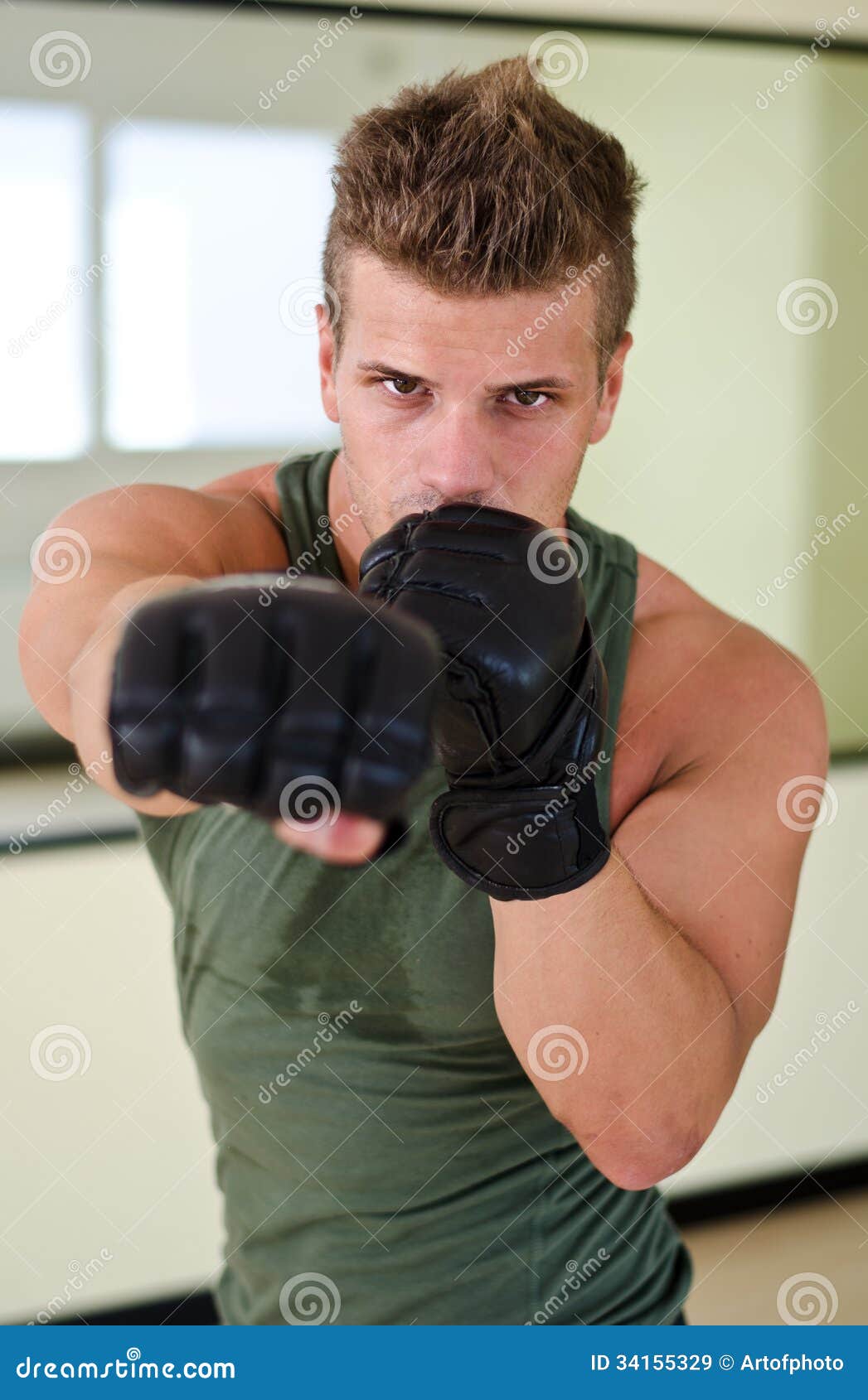 Young Man with Boxer S Gloves Throwing Punch Towards Camera Stock Image ...