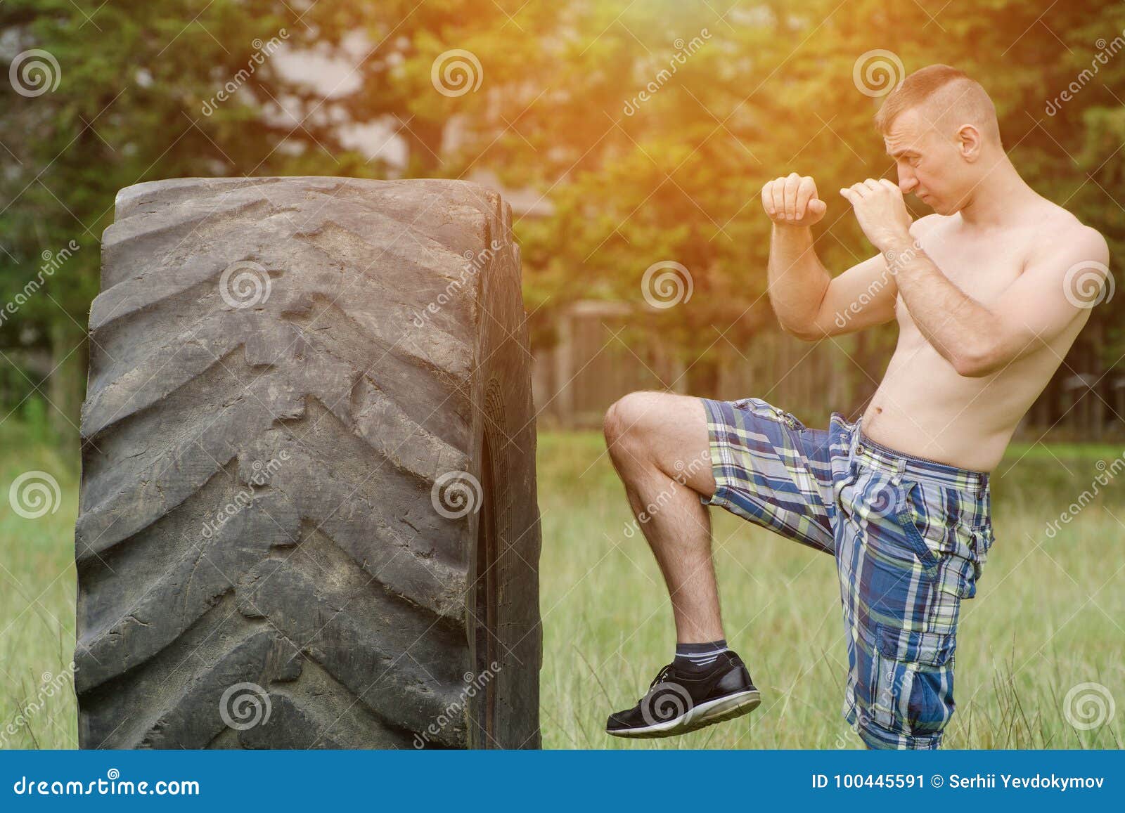 Young Man Boxing with the Tire. Workout Stock Image - Image of athletic ...