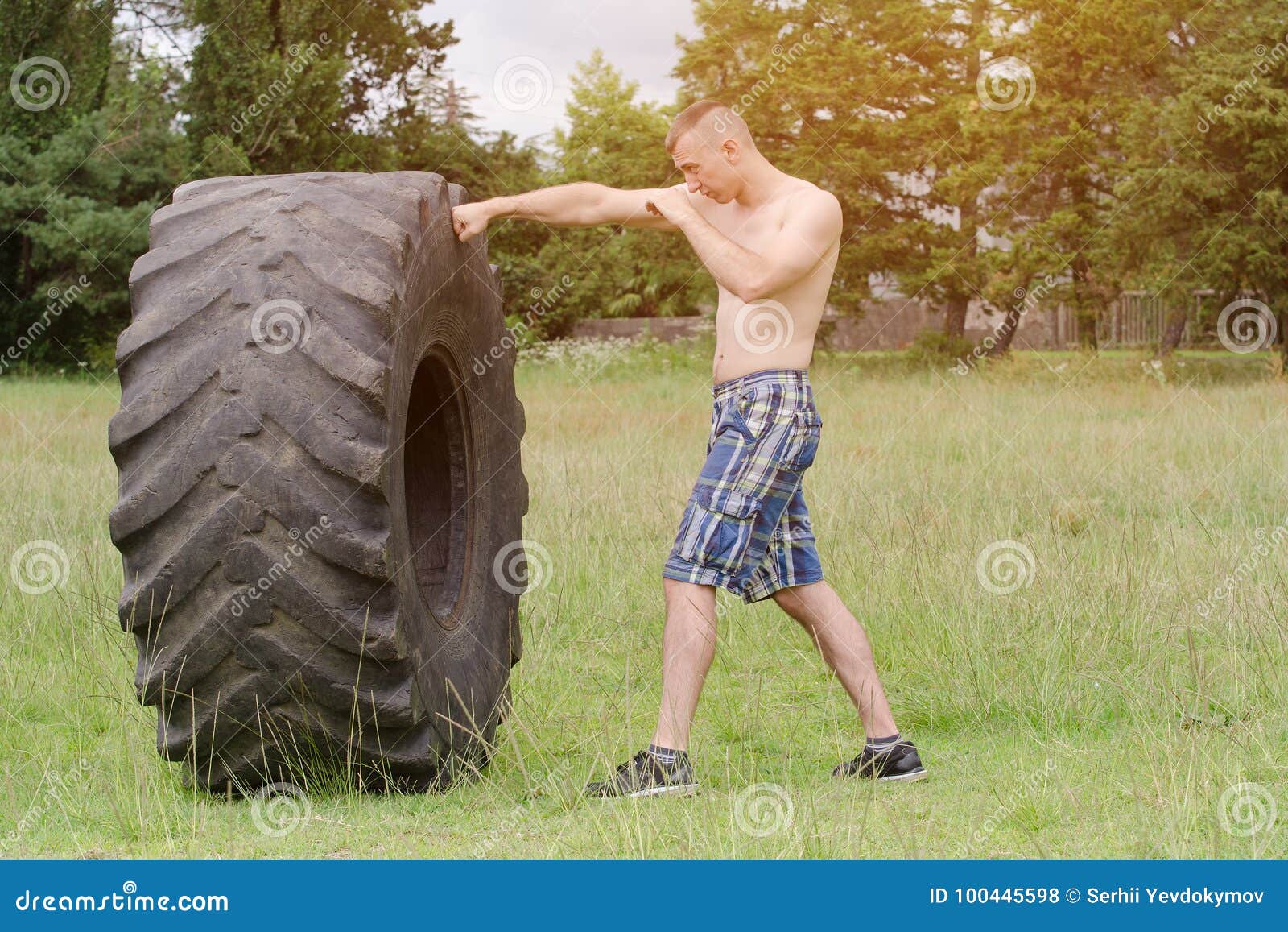 Young Man Boxing with the Tire. Workout Stock Photo - Image of green ...