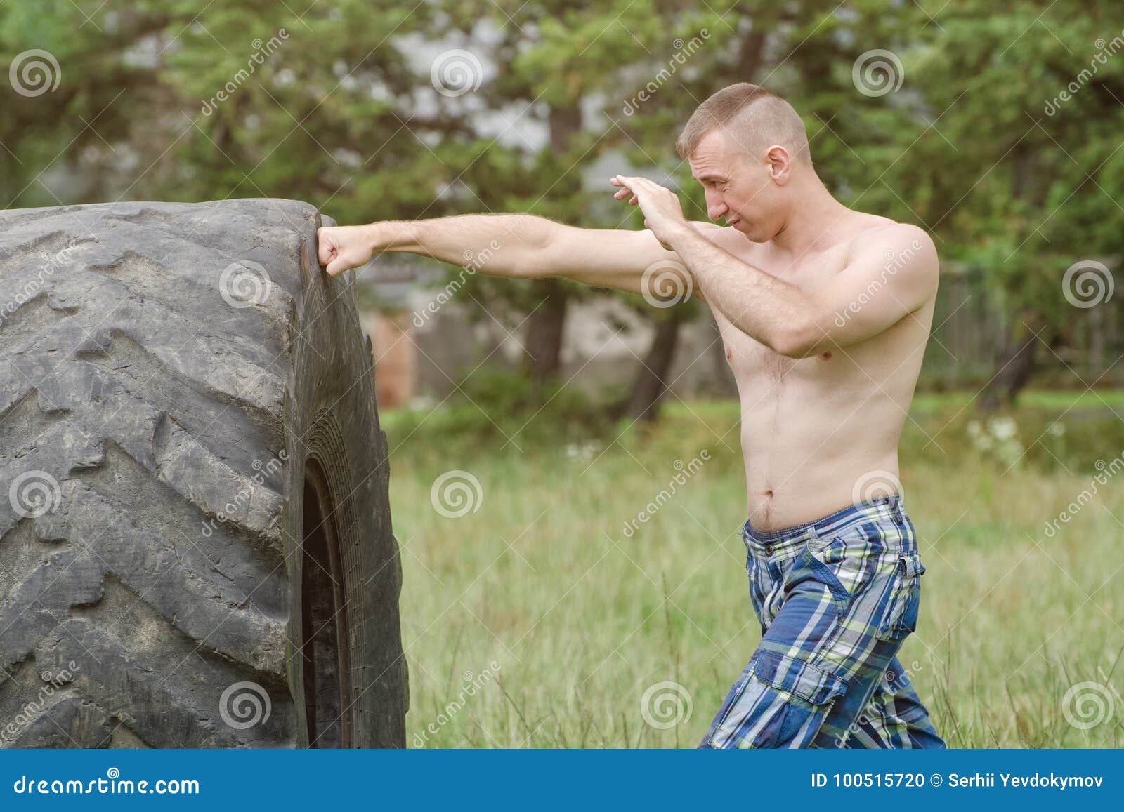 Young Man Boxing with the Tire. Workout Stock Photo - Image of people ...