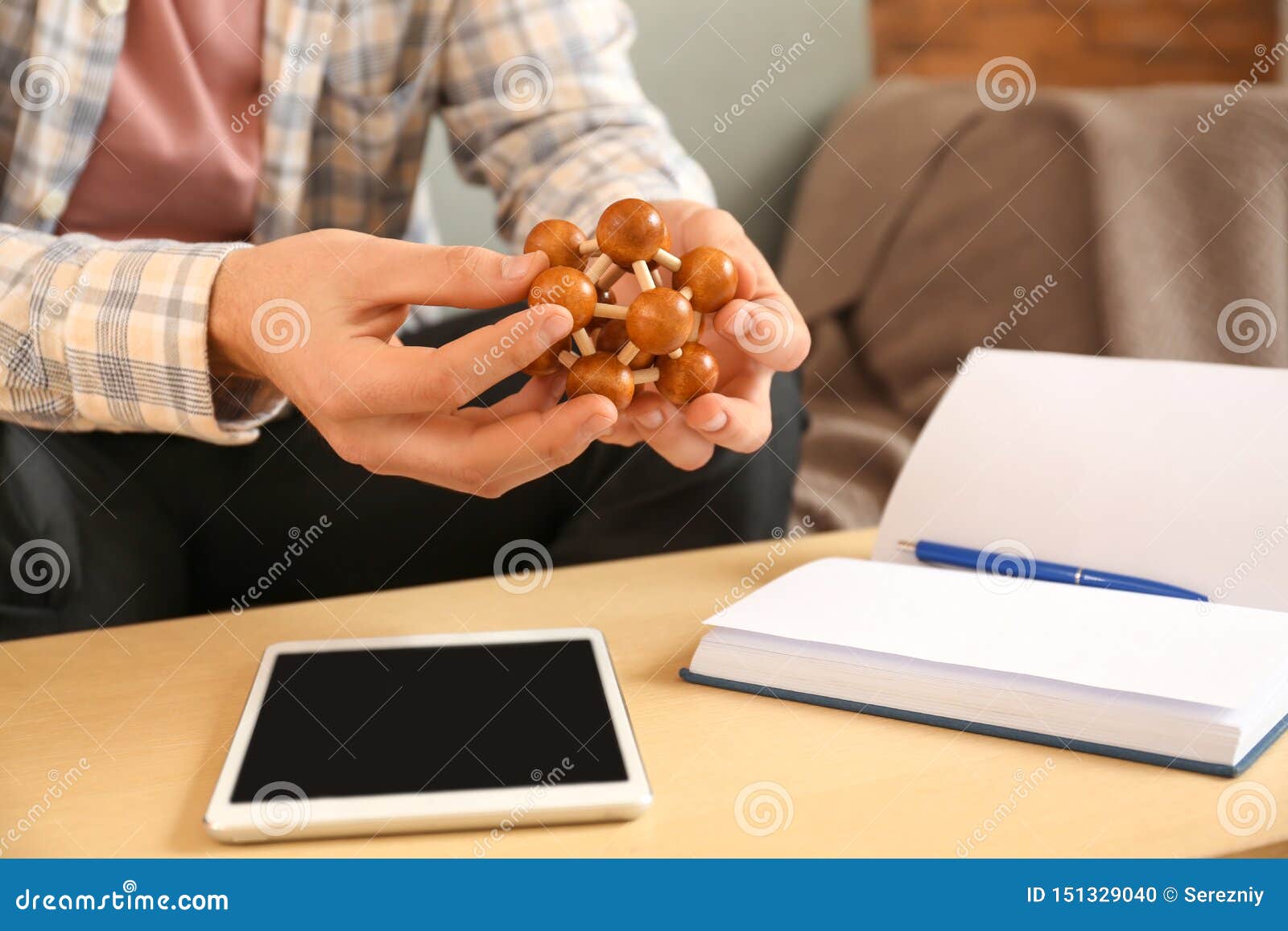 Young Man with Brain Teaser at Table Indoors Stock Photo - Image of ...