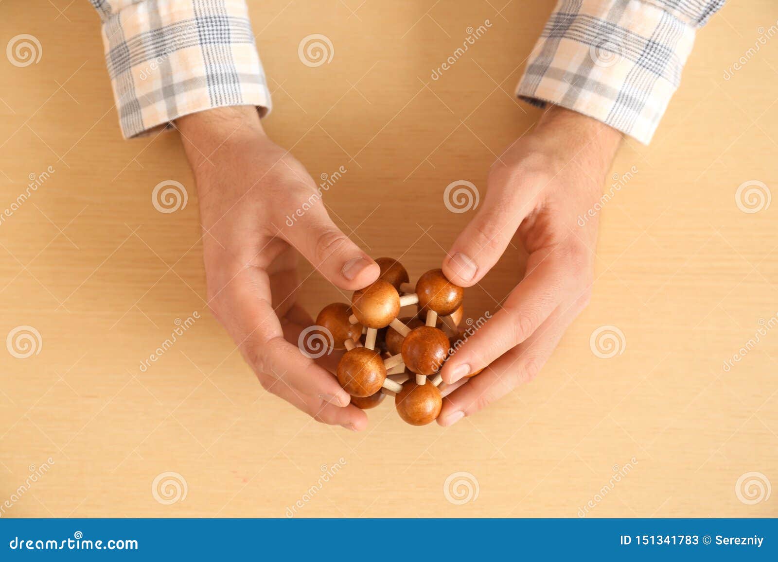 Young Man with Brain Teaser at Wooden Table Stock Image - Image of ...