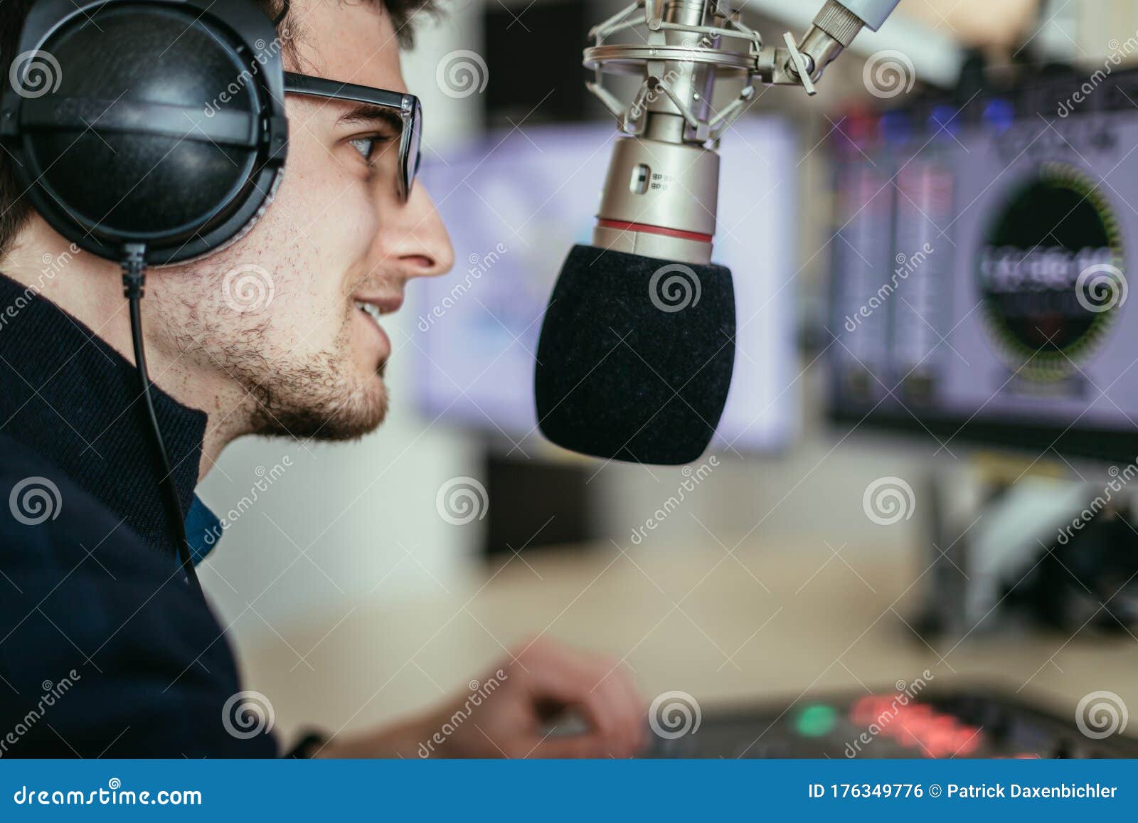 Radio Moderator is Sitting in a Modern Broadcasting Studio and Talking ...