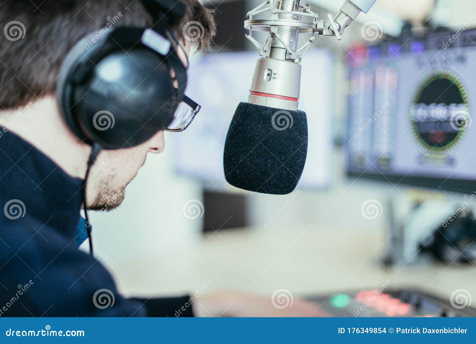 Radio Moderator is Sitting in a Modern Broadcasting Studio and Talking ...