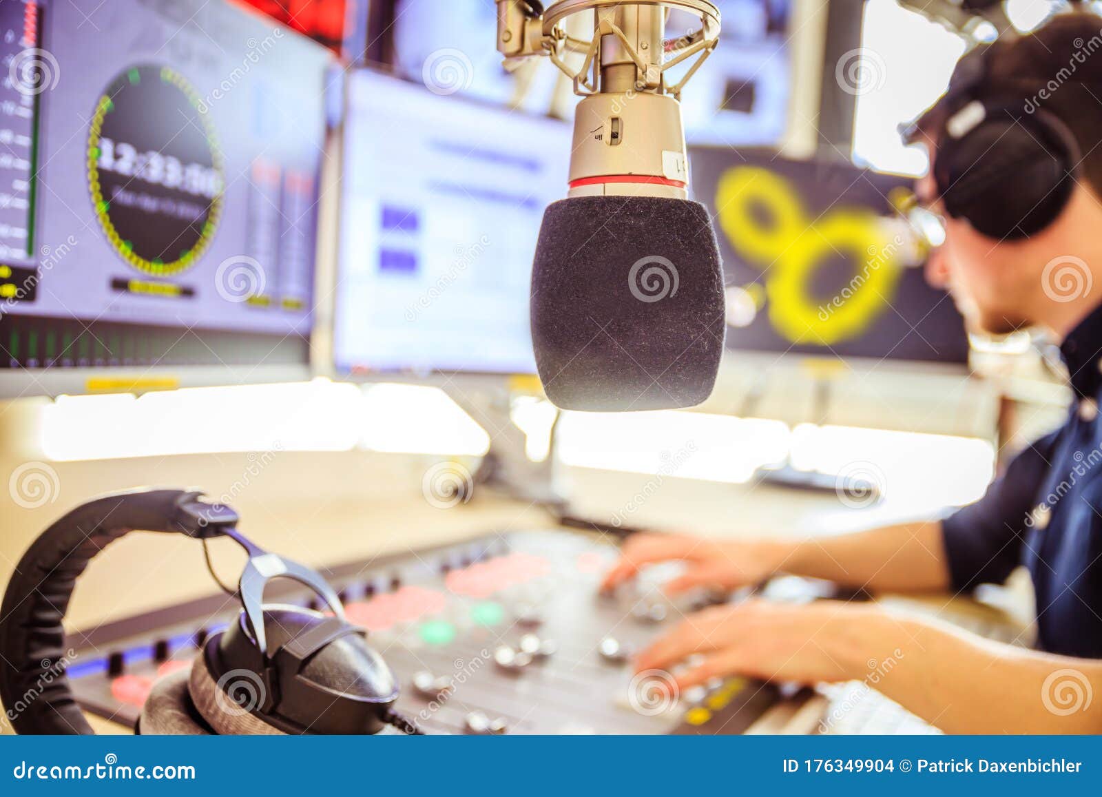 Radio Moderator is Sitting in a Modern Broadcasting Studio and Talking ...