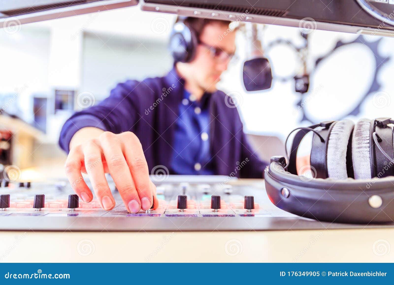 Radio Moderator is Sitting in a Modern Broadcasting Studio and Talking ...