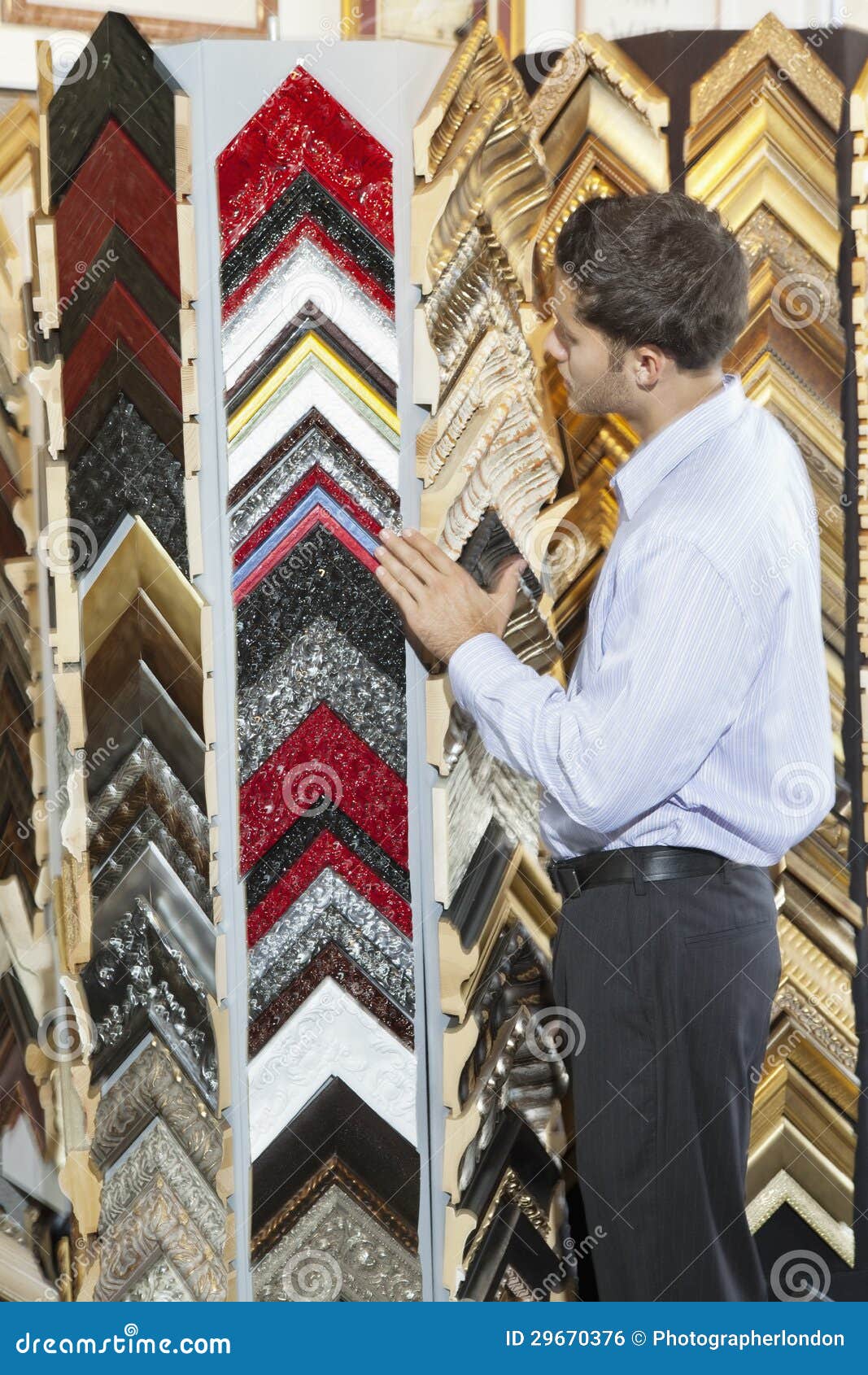 Young Man Browsing at a Frame Store Stock Photo - Image of people ...