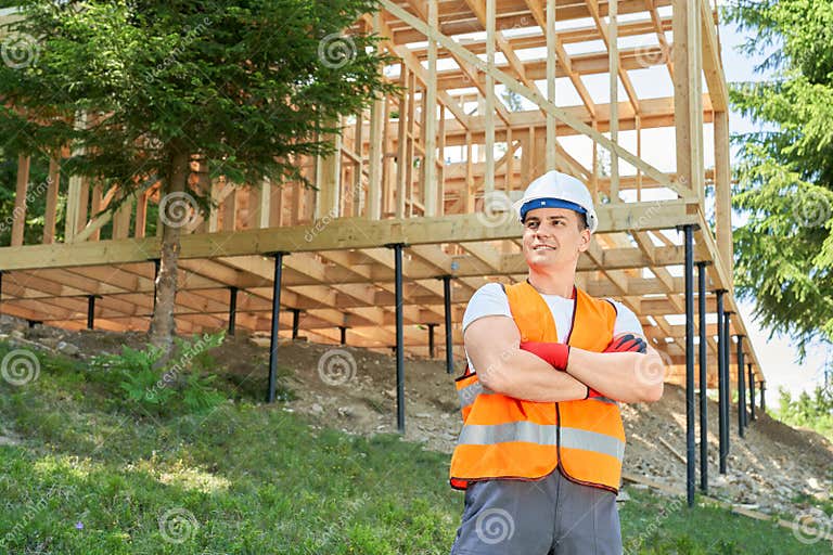 Young Man, Builder Wearing Uniform and Helmet, Standing with Crossed ... Young Man, Builder Wearing Uniform and Helmet, Standing with Crossed ...