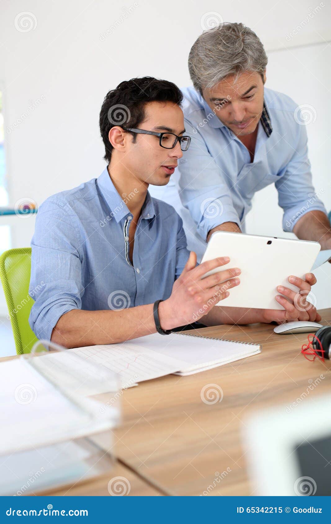 Young Man in Business Training with Professor Using Tablet Stock Image ...