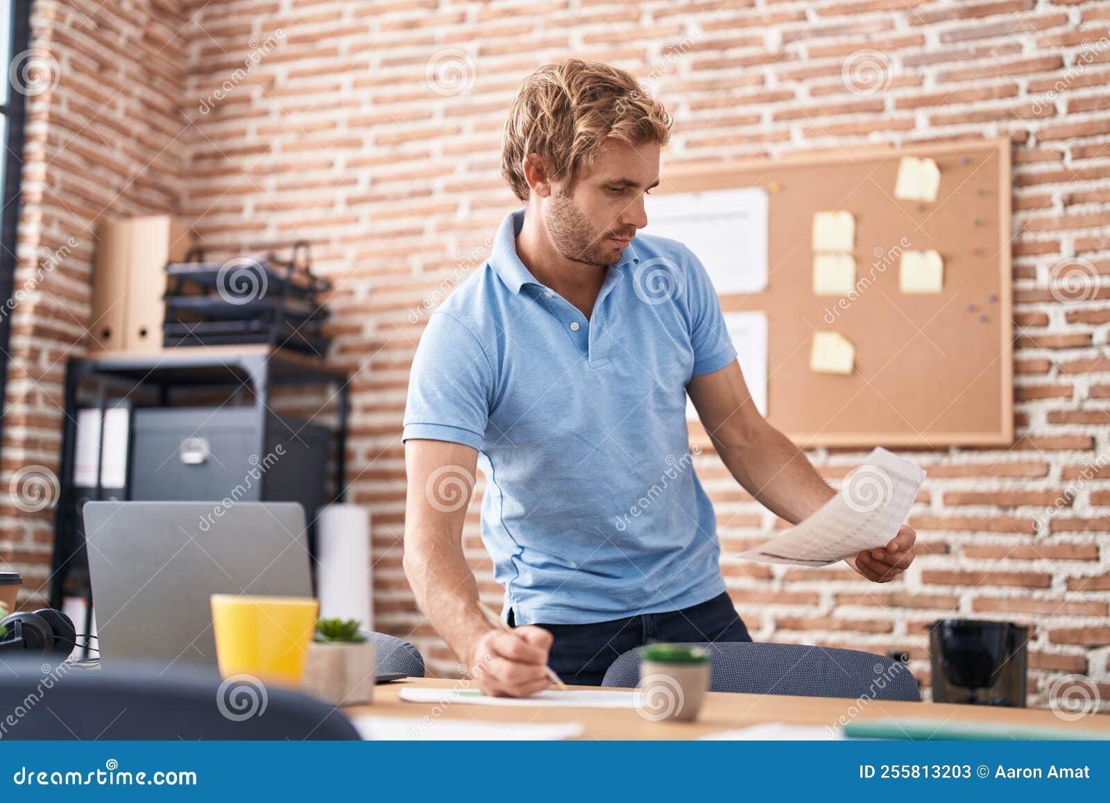 Young Man Business Worker Write on Document Standing at Office Stock ... Young Man Business Worker Write on Document Standing at Office Stock ...