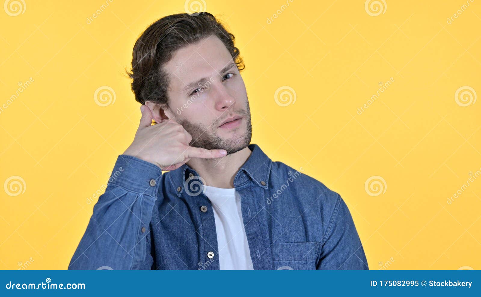 Young Man with Call Me Sign, Hand Gesture on Yellow Background Stock ...