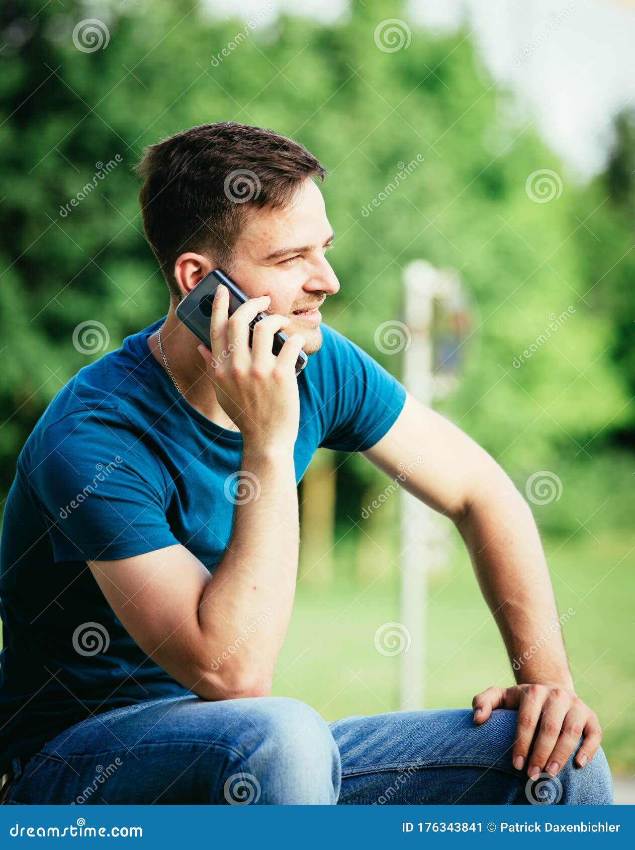 Young Man Calling Outdoors: Handsome Young Man is Sitting and Calling ...